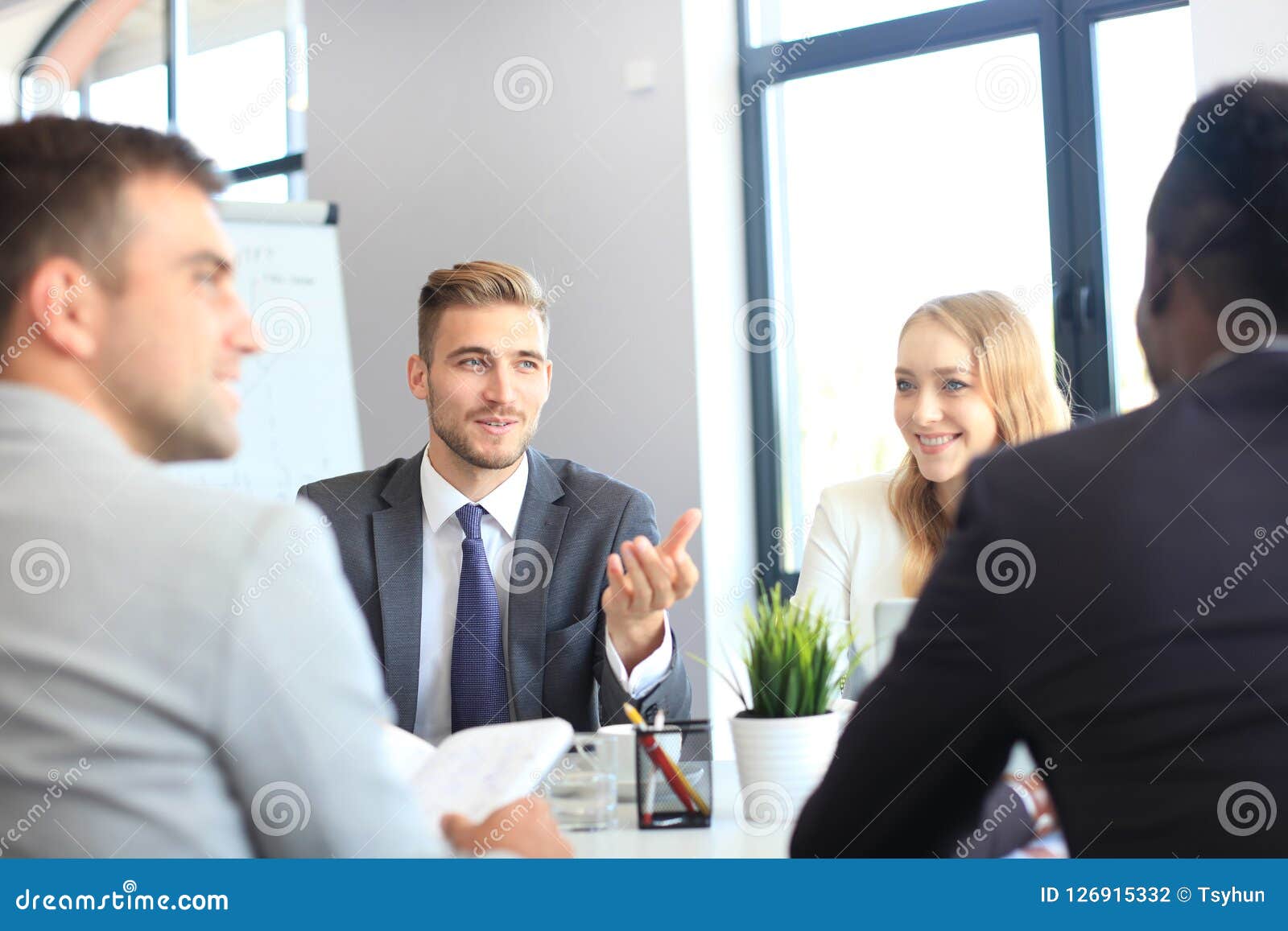 Business People in Discussing Something while Sitting Together at the ...