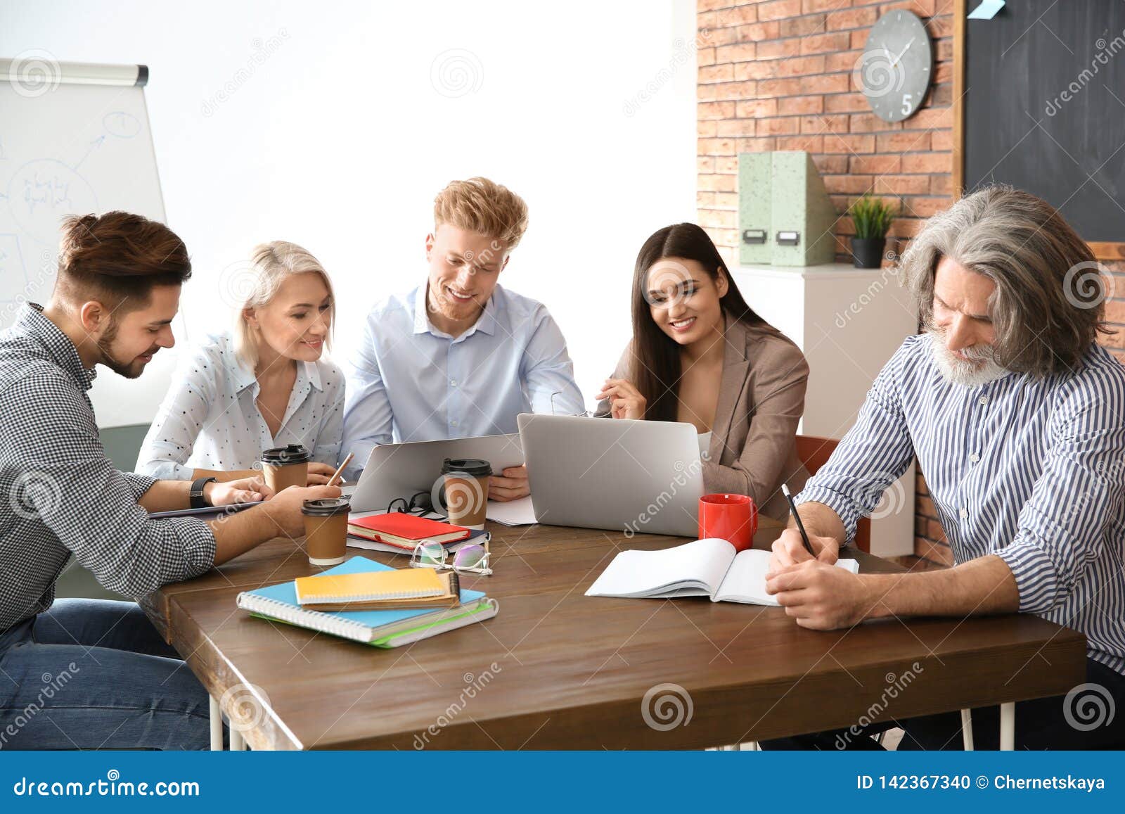 Business People Discussing Work Matters at Table in Office Stock Photo ...
