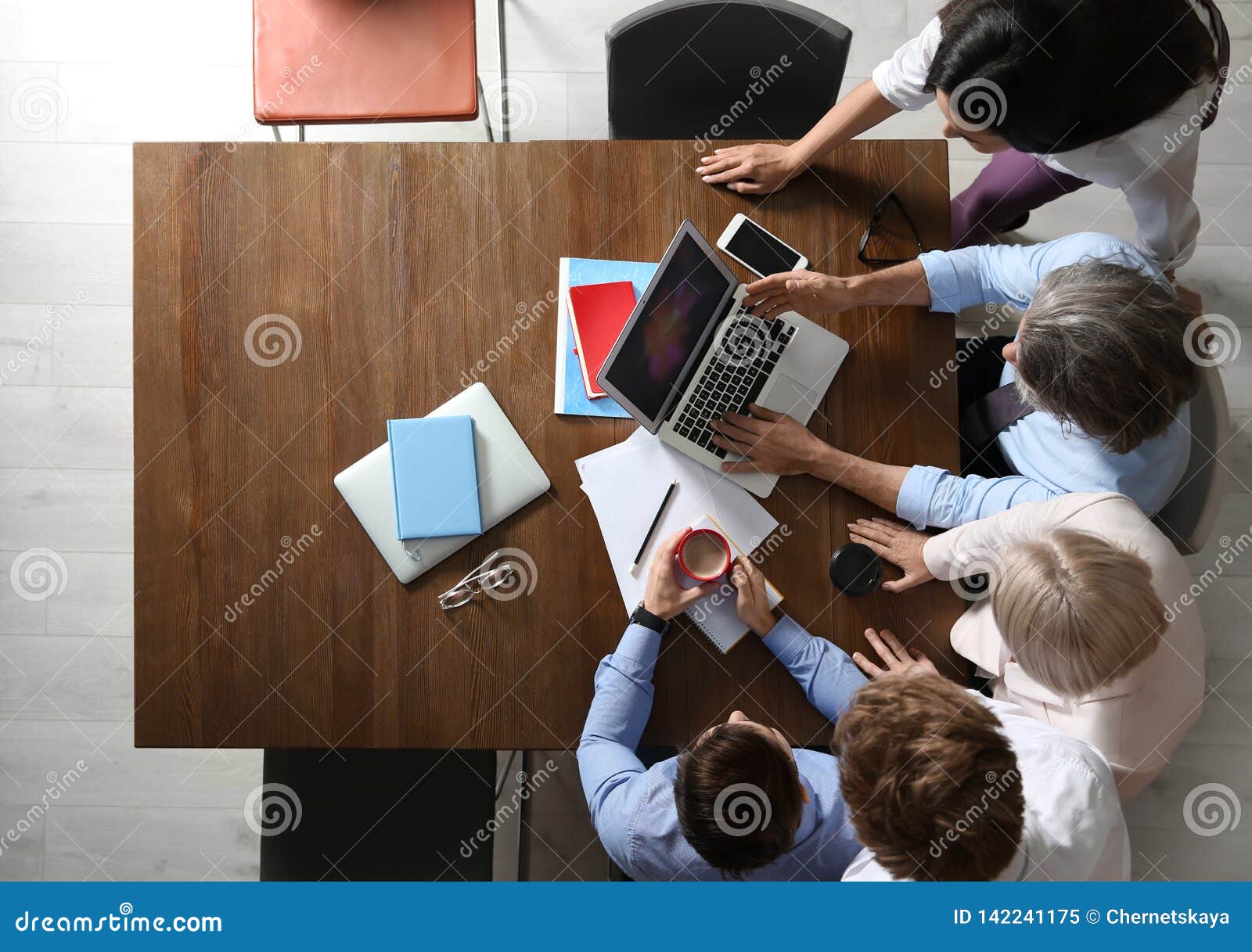 Business People Discussing Work Matters at Table in Office, Top View ... Business People Discussing Work Matters at Table in Office, Top View ...