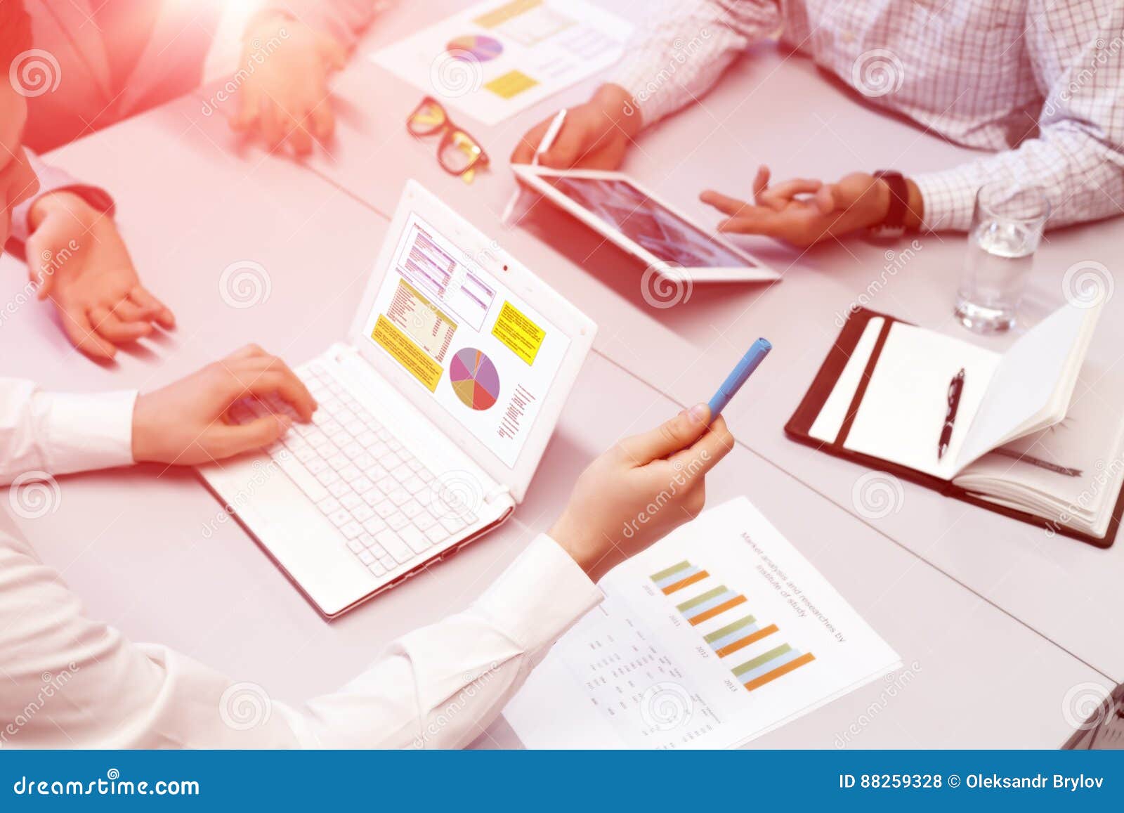 Business People Discussion at Table Using Variety of Electronic Devices ...