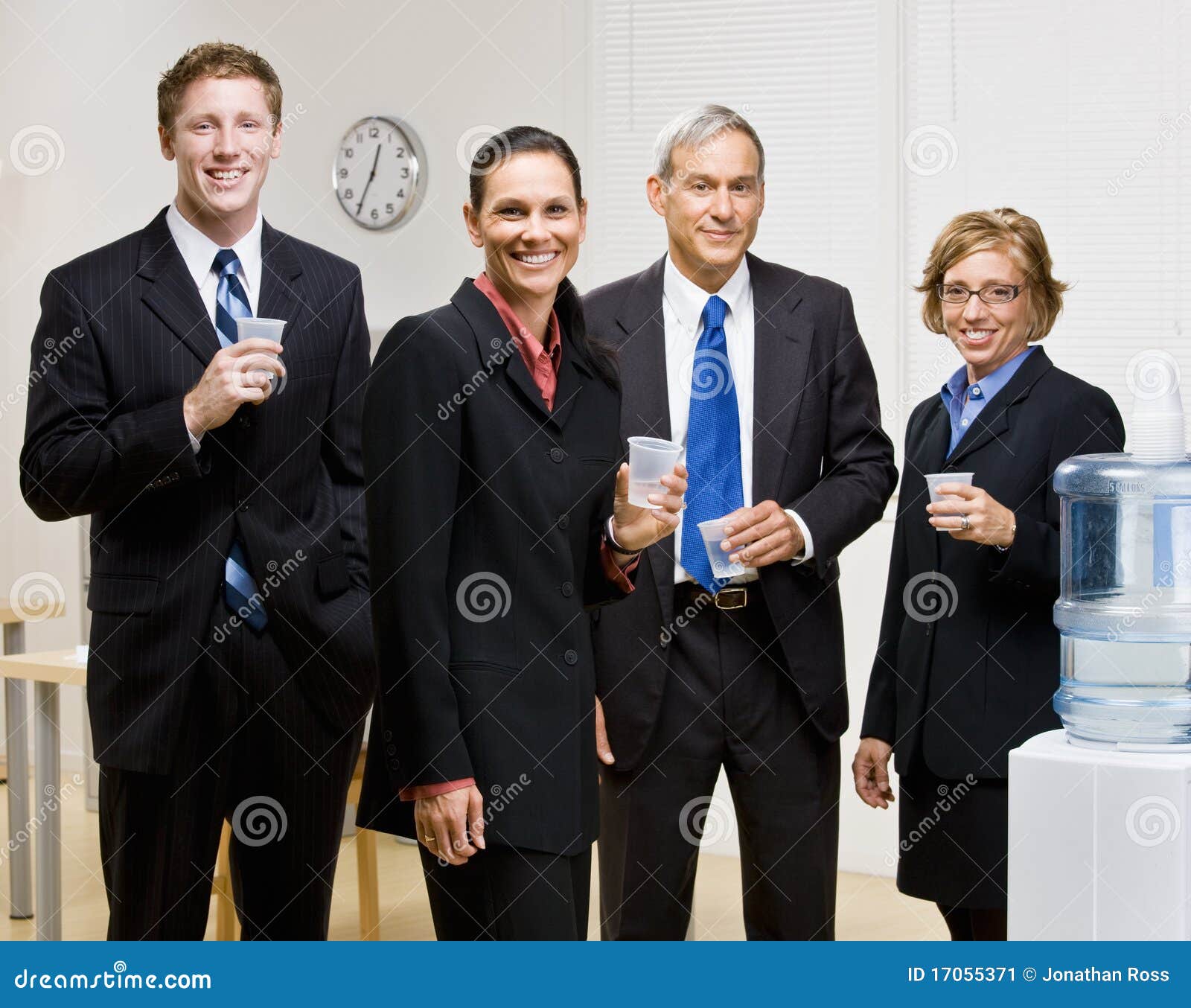 Business People Drinking Water at Water Cooler Stock Image - Image of ...