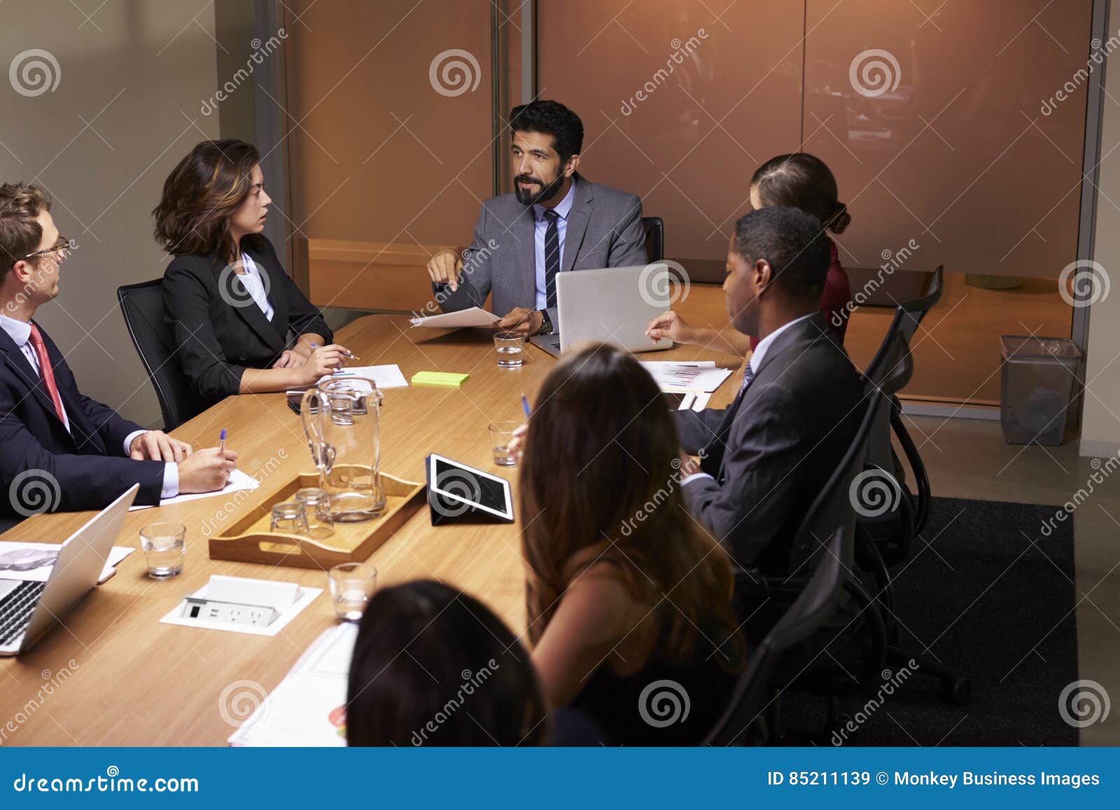 Business People at Evening Boardroom Meeting, Elevated View Stock Image ...