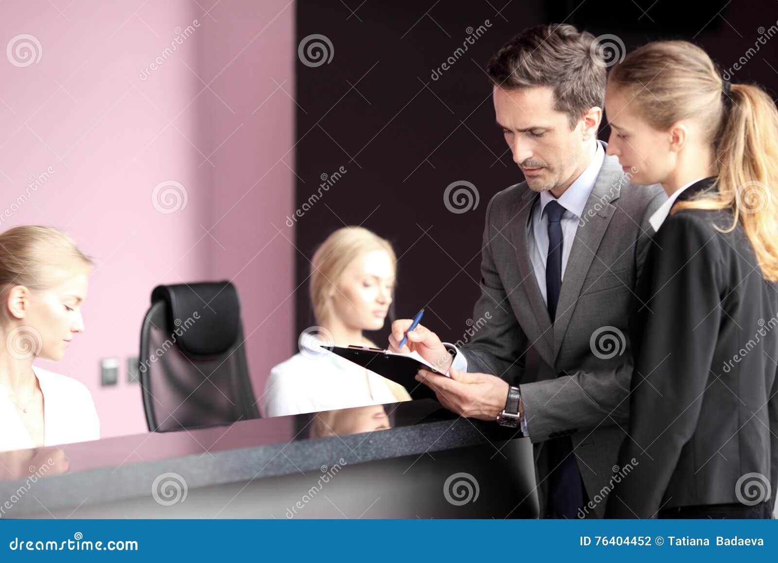 Business People at Front Desk Stock Photo - Image of receptionist ...