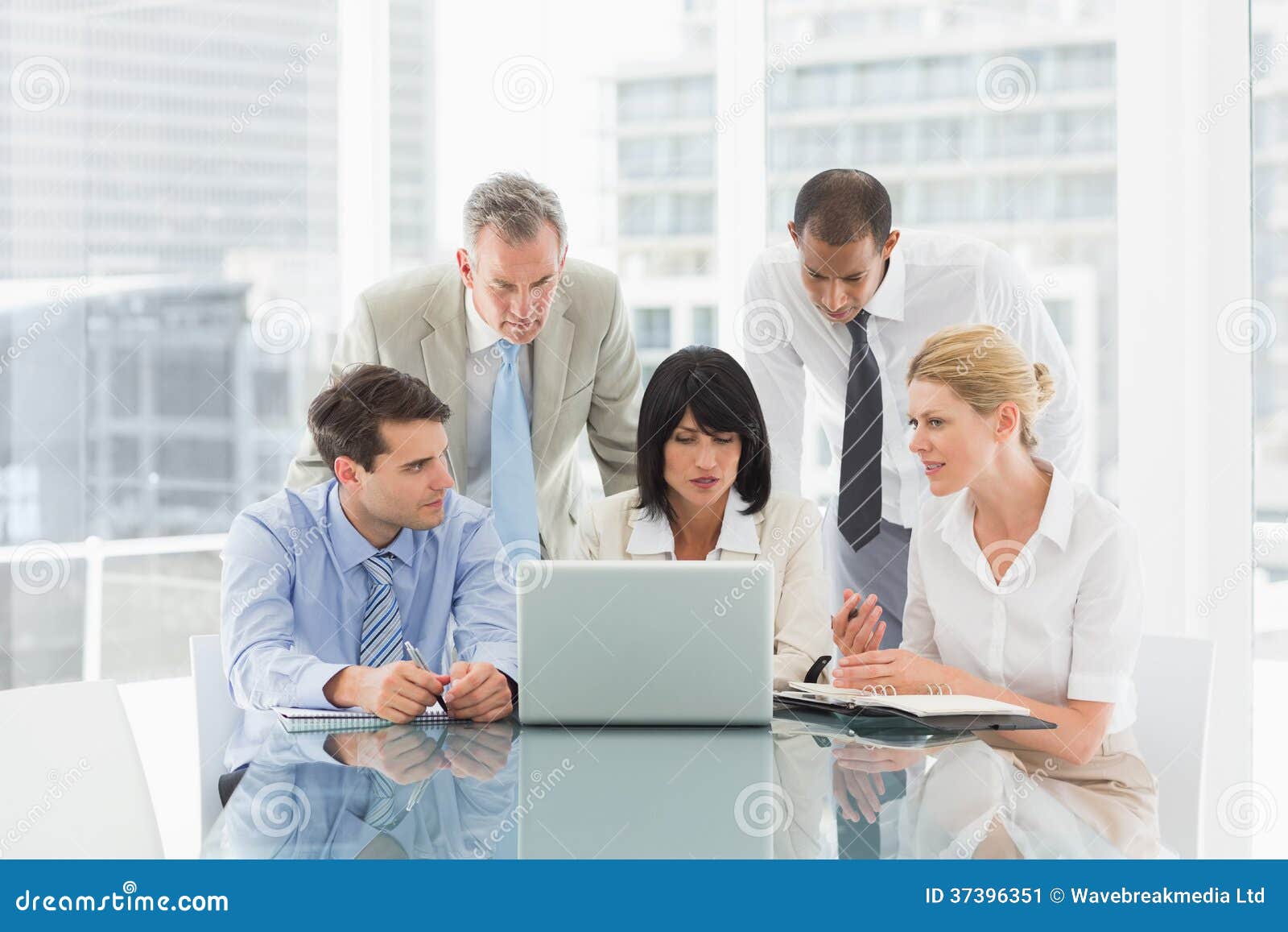 Business People Gathered Around Laptop Talking Stock Image - Image of ...