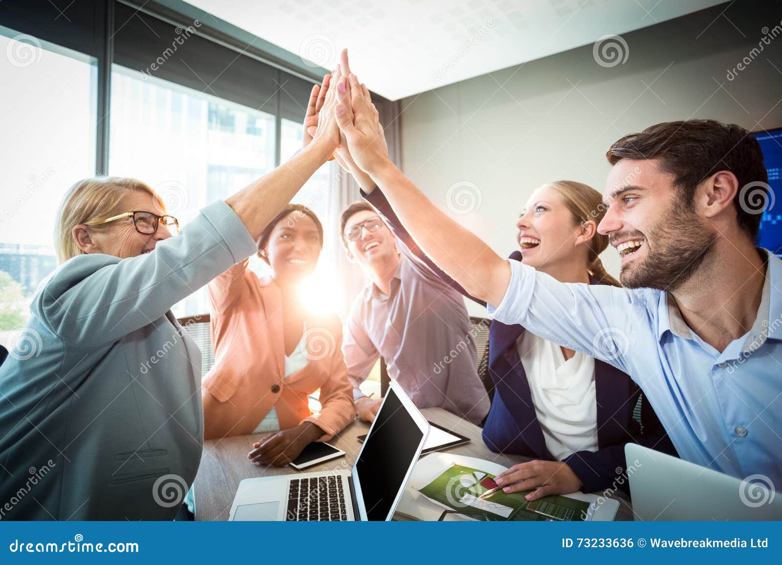 Business People Giving High Five at Desk Stock Photo - Image of ...