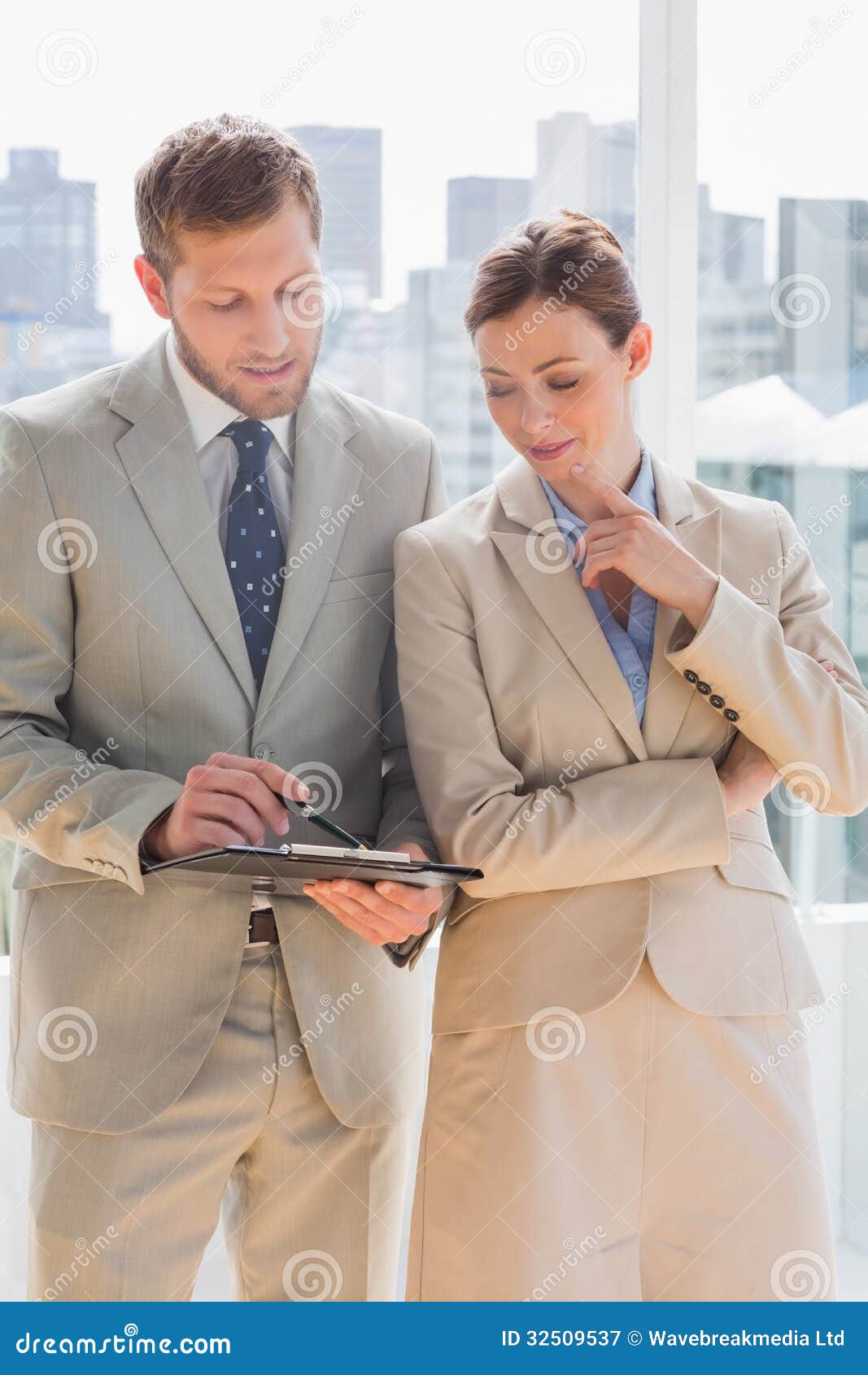 Business People Going Over Document on Clipboard Stock Image - Image of ...