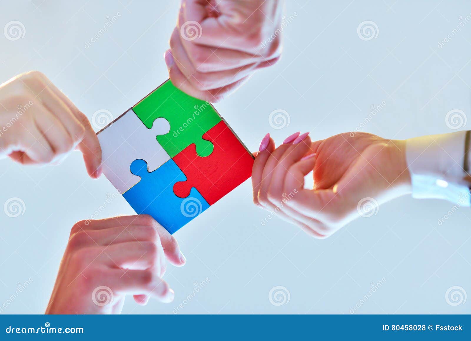 Business People Group Assembling Jigsaw Puzzle and Represent Team ...