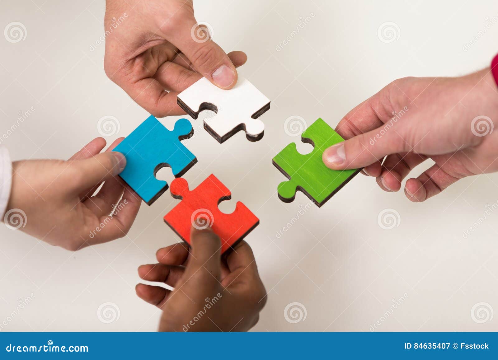Business People Group Assembling Jigsaw Puzzle and Represent Team ...