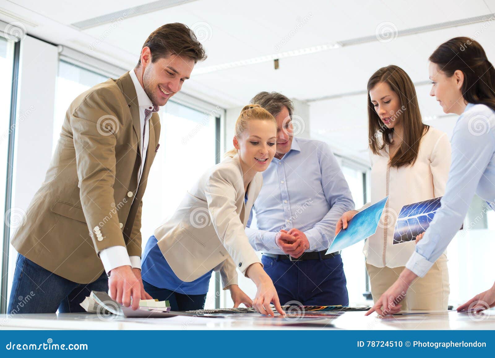 Business People Having Discussion at Table in New Office Stock Photo ...