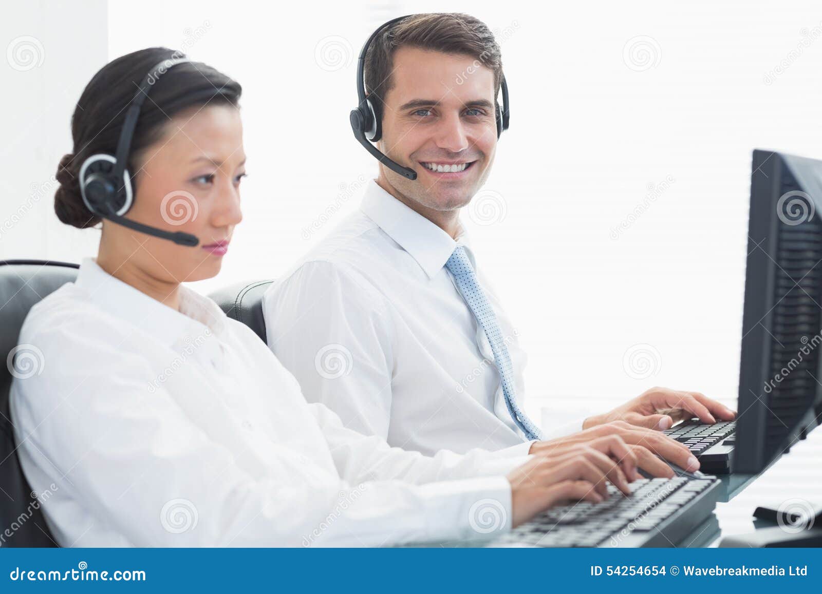 Business People with Headsets Using Computers Stock Photo - Image of ...