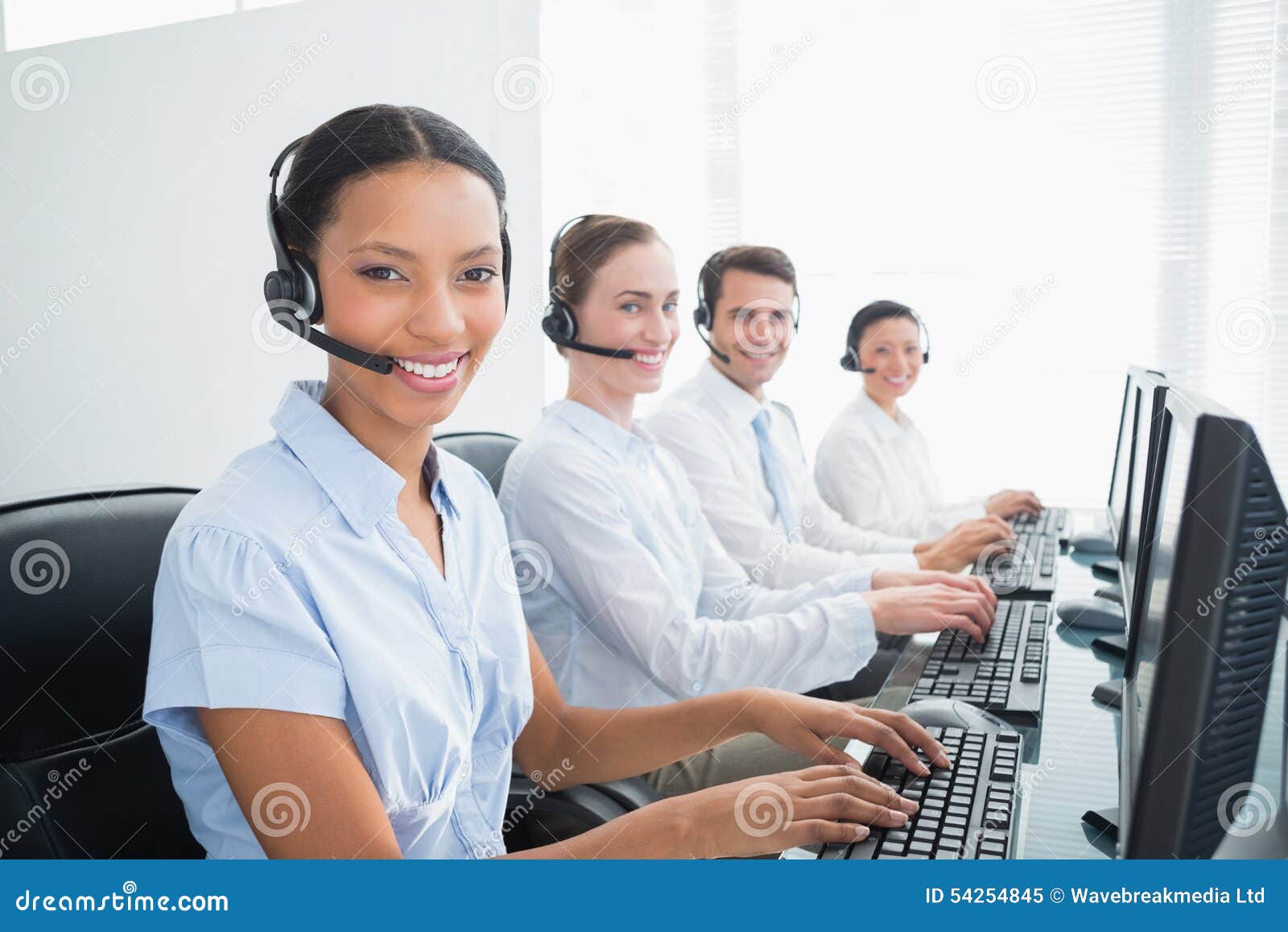Business People with Headsets Using Computers Stock Image - Image of ...