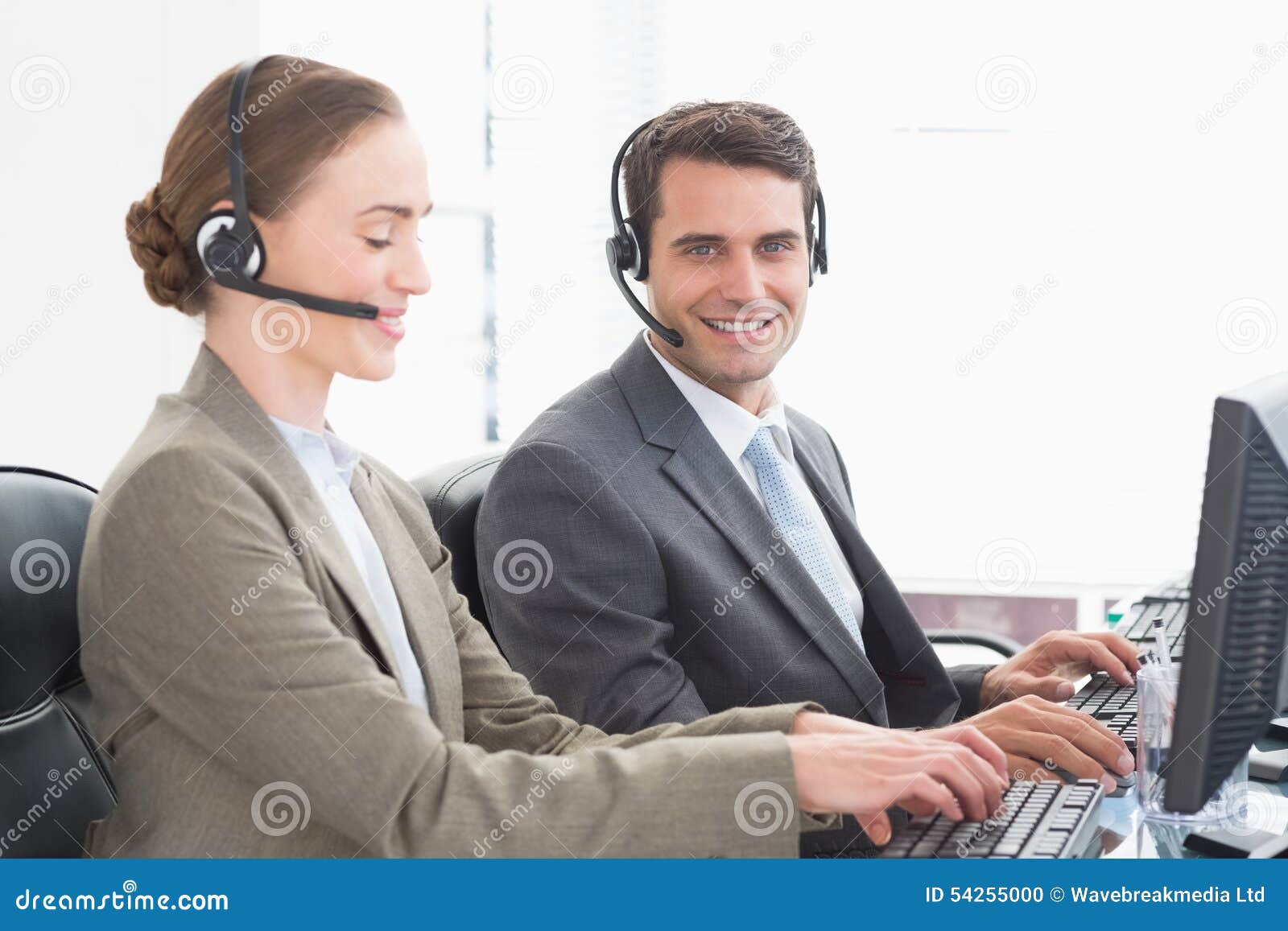 Business People with Headsets Using Computers Stock Photo - Image of ...
