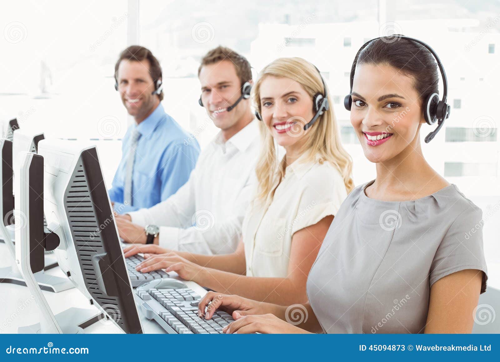 Business People with Headsets Using Computers in Office Stock Image ...