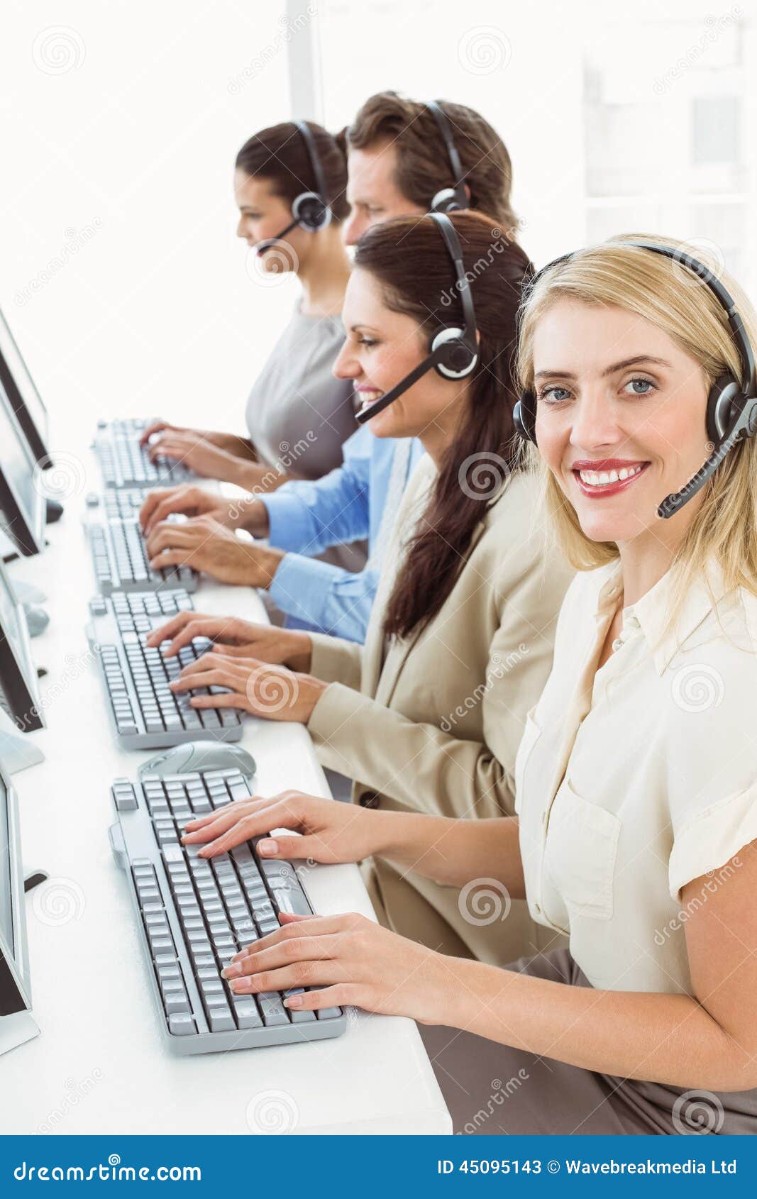 Business People with Headsets Using Computers in Office Stock Image ...