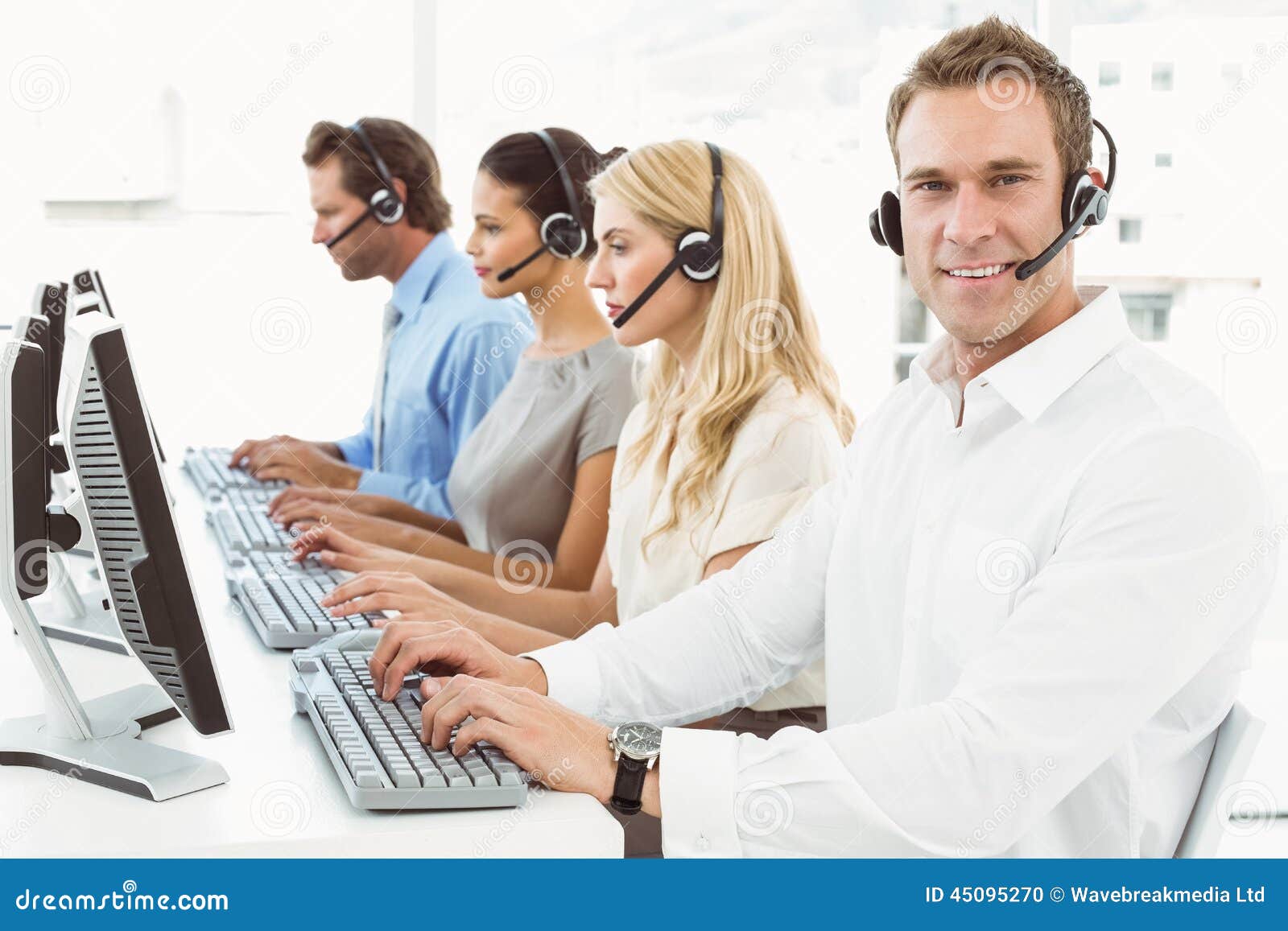 Business People with Headsets Using Computers in Office Stock Photo ...