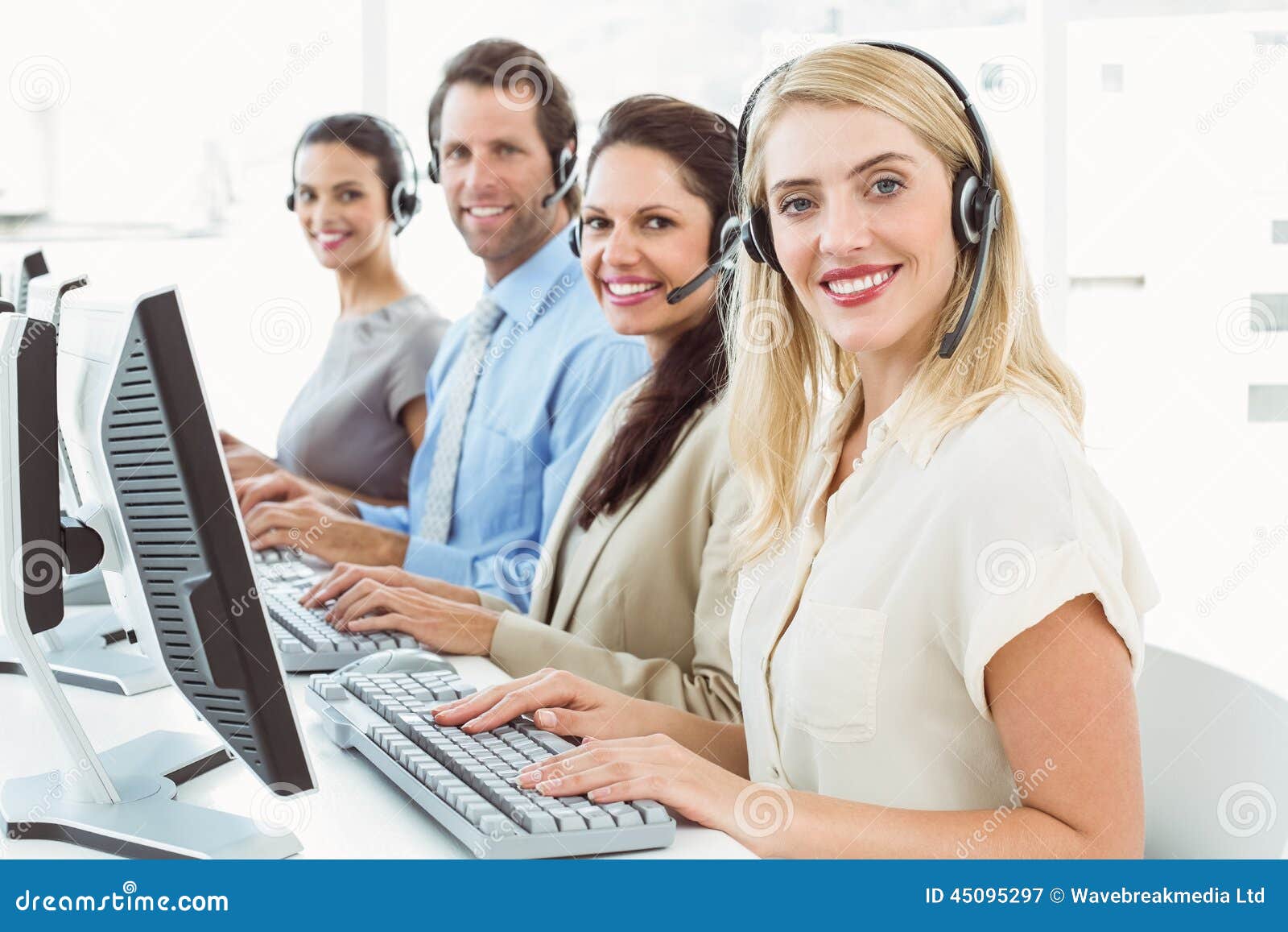 Business People with Headsets Using Computers in Office Stock Image ...