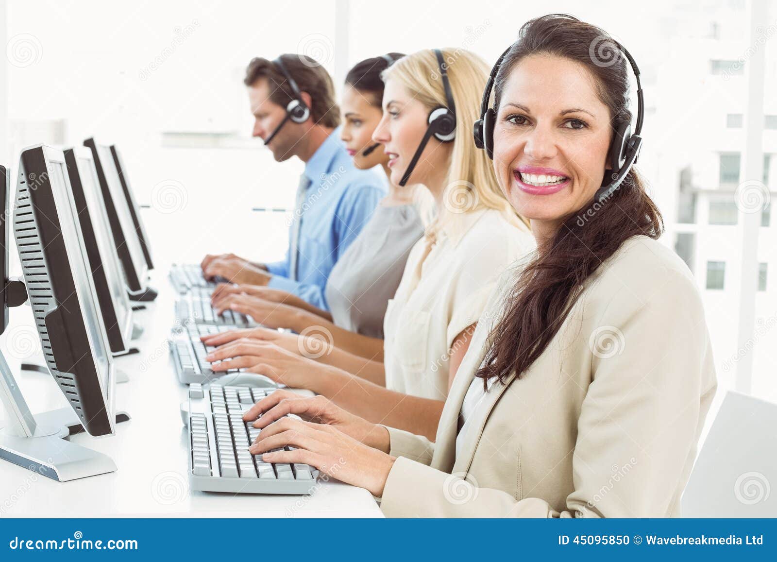 Business People with Headsets Using Computers in Office Stock Photo ...