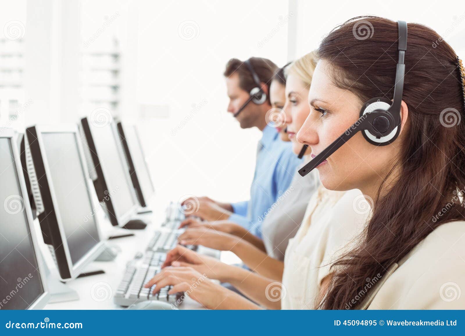 Business People with Headsets Using Computers in Office Stock Image ...