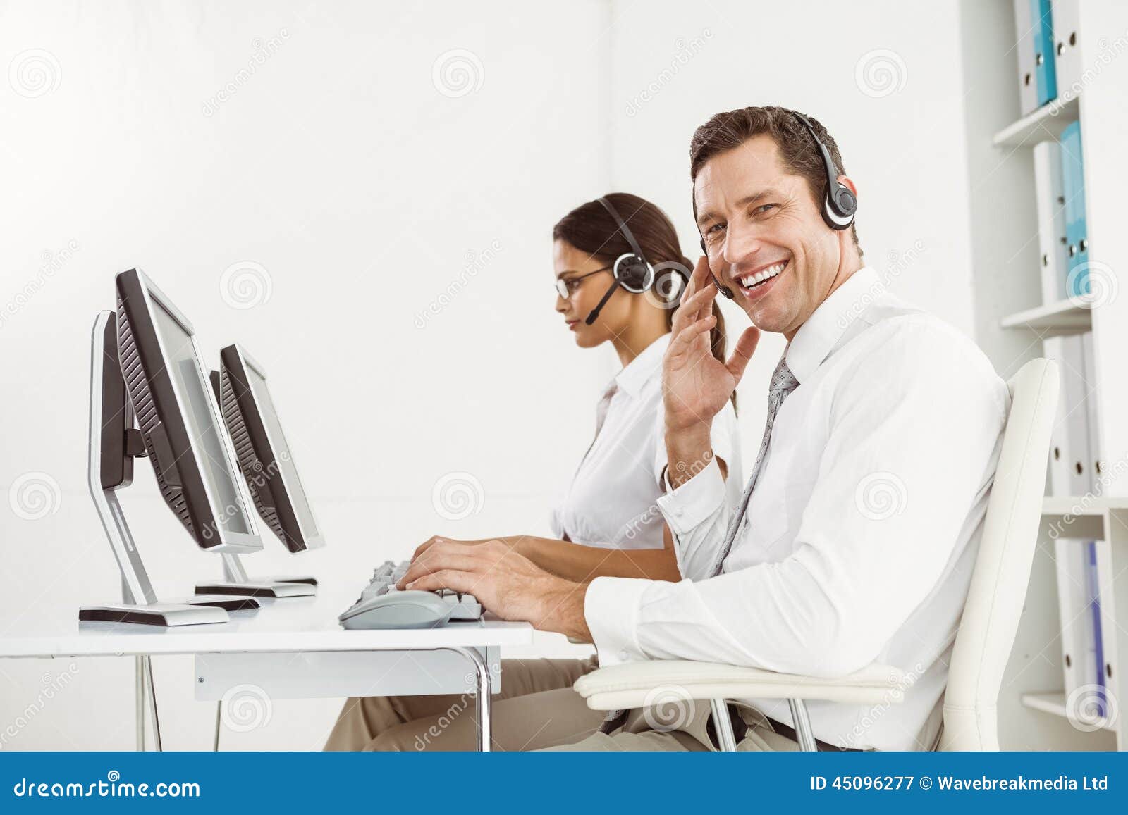 Business People with Headsets Using Computers in Office Stock Image ...