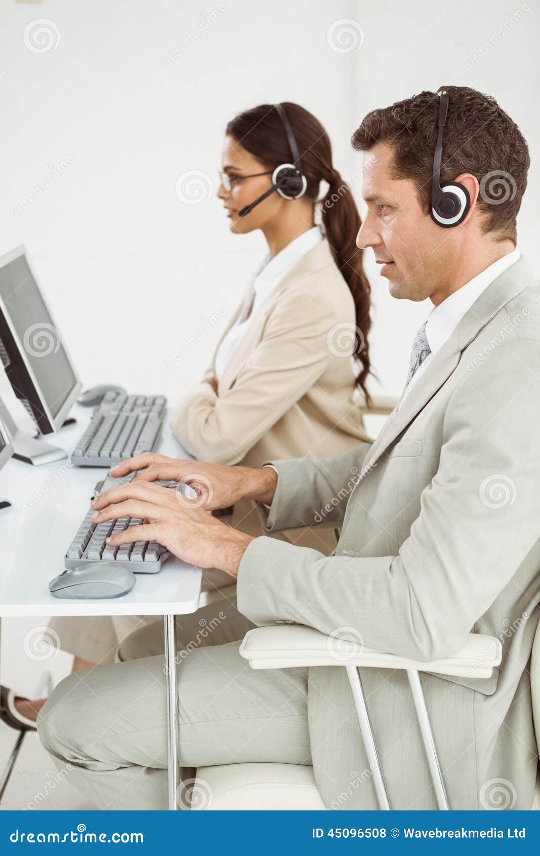 Business People with Headsets Using Computers in Office Stock Photo ...