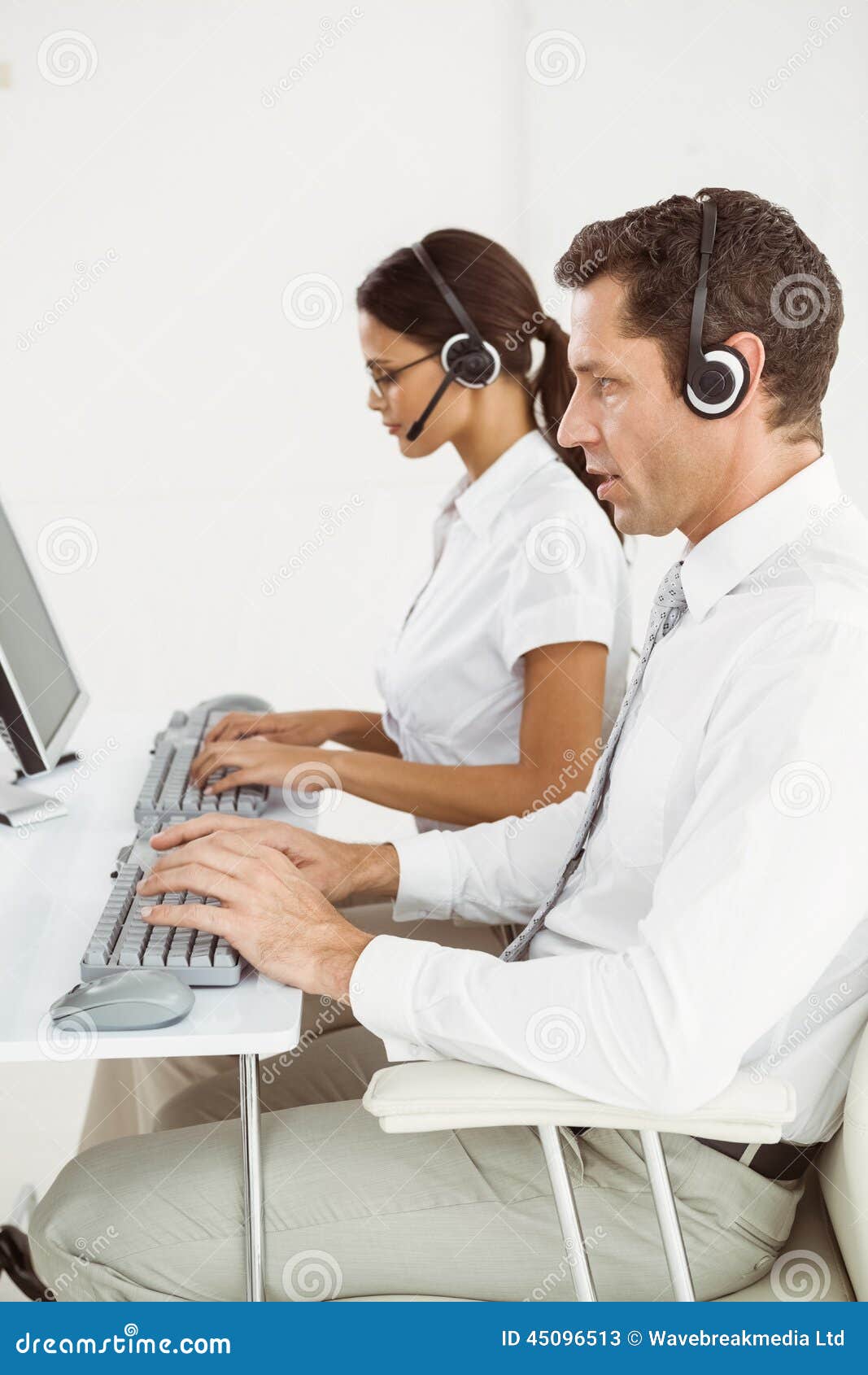 Business People with Headsets Using Computers in Office Stock Image ...