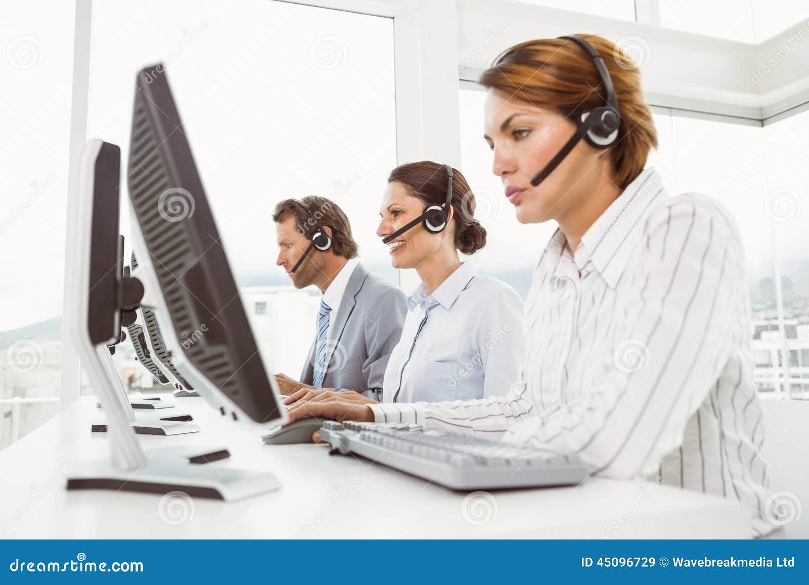 Business People with Headsets Using Computers in Office Stock Image ...