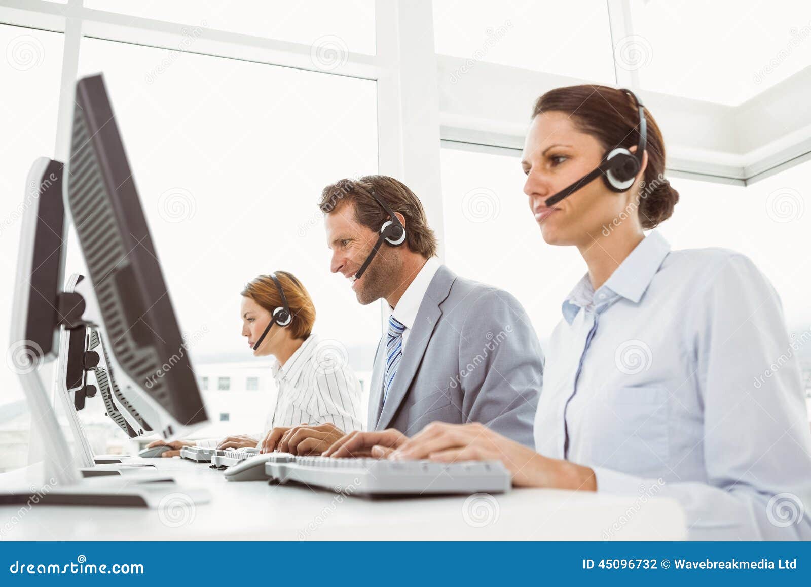 Business People with Headsets Using Computers in Office Stock Photo ...