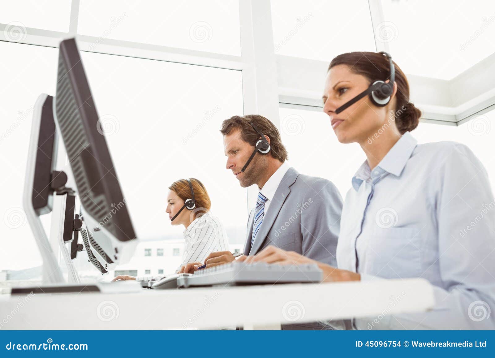 Business People with Headsets Using Computers in Office Stock Photo ...