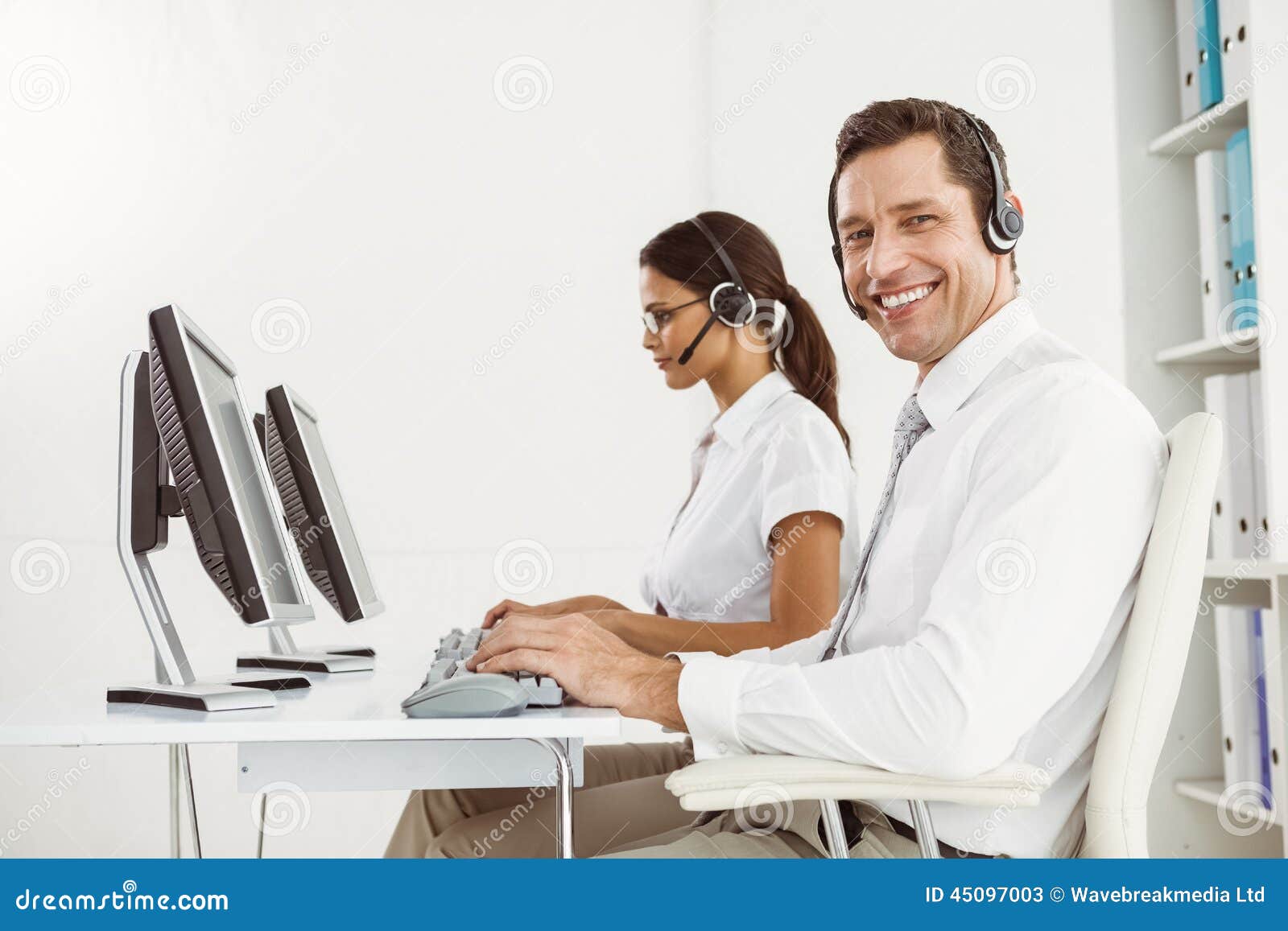 Business People with Headsets Using Computers in Office Stock Image ...