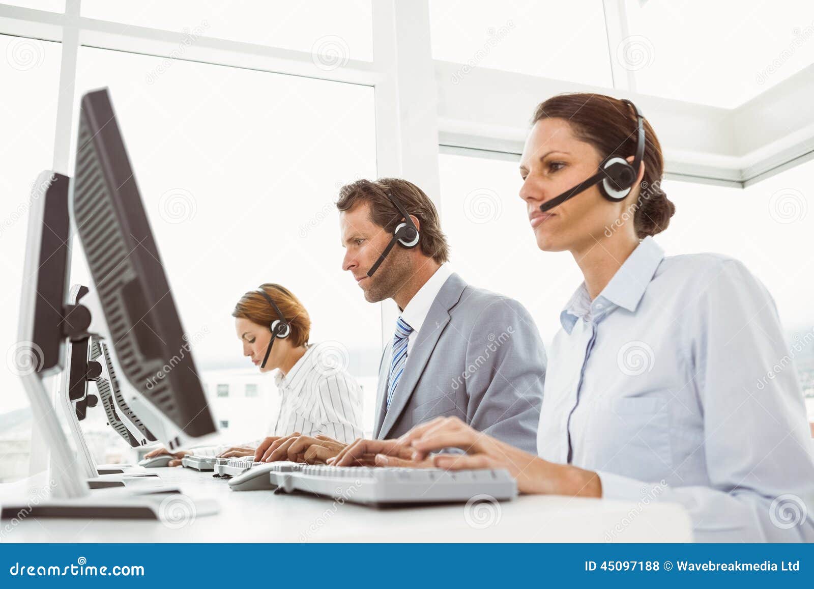 Business People with Headsets Using Computers in Office Stock Photo ...