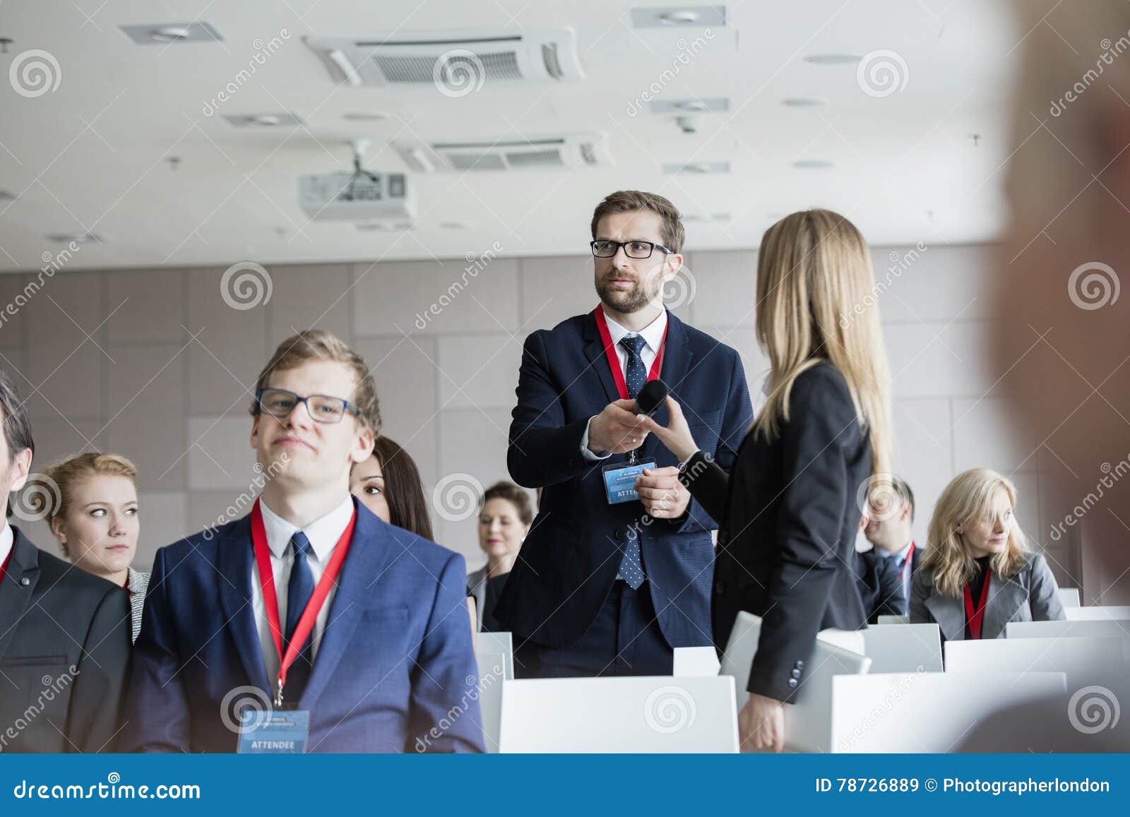 Business People Holding Microphone while Standing during Seminar Stock ...