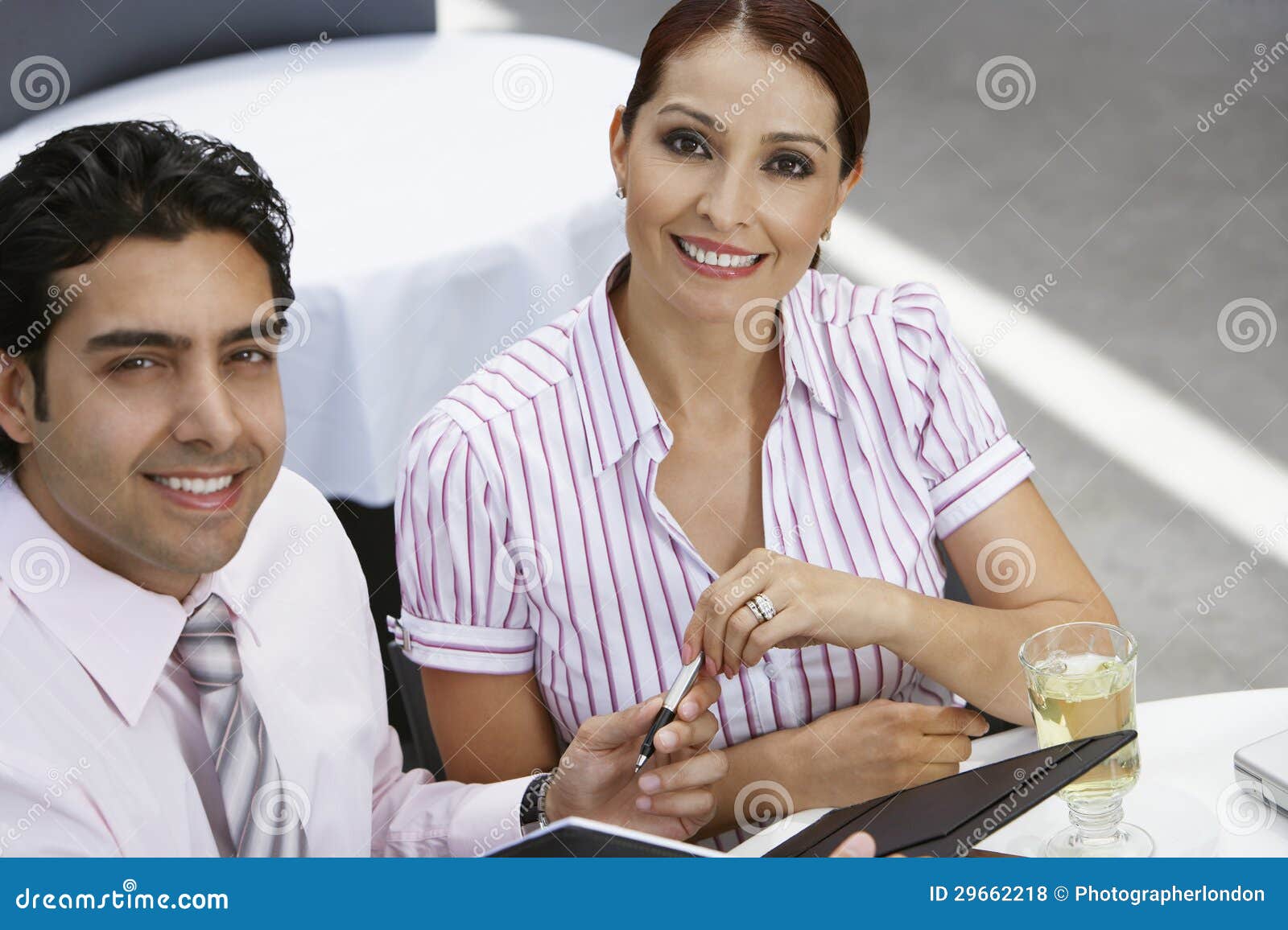 Business People Holding Pen in a Restaurant Stock Photo - Image of ...