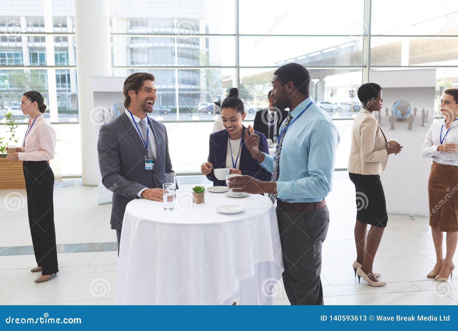 Business People Interacting with Each Other at Table during a Seminar ... Business People Interacting with Each Other at Table during a Seminar ...
