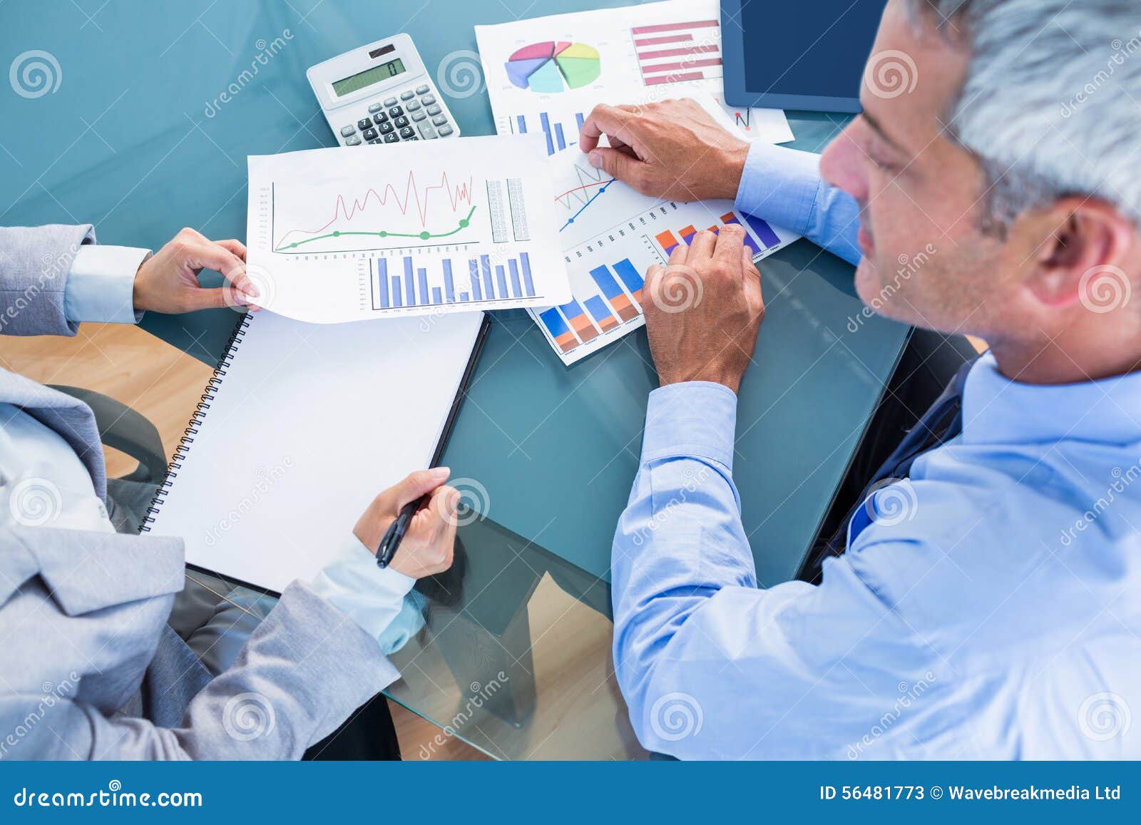Business People Looking at Documents with Graphics Stock Image - Image ...