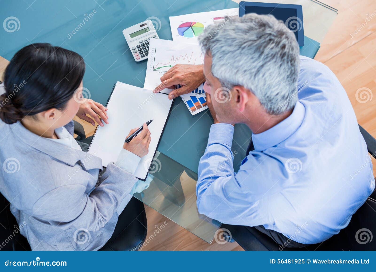 Business People Looking at Documents with Graphics Stock Image - Image ...