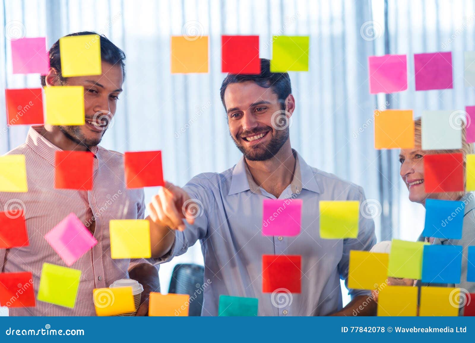 Business People Looking at Post it on the Wall Stock Photo - Image of ...
