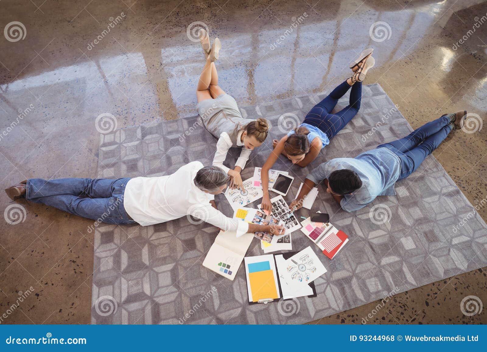 Business People Lying on Carpet while Working in Creative Office Stock ...