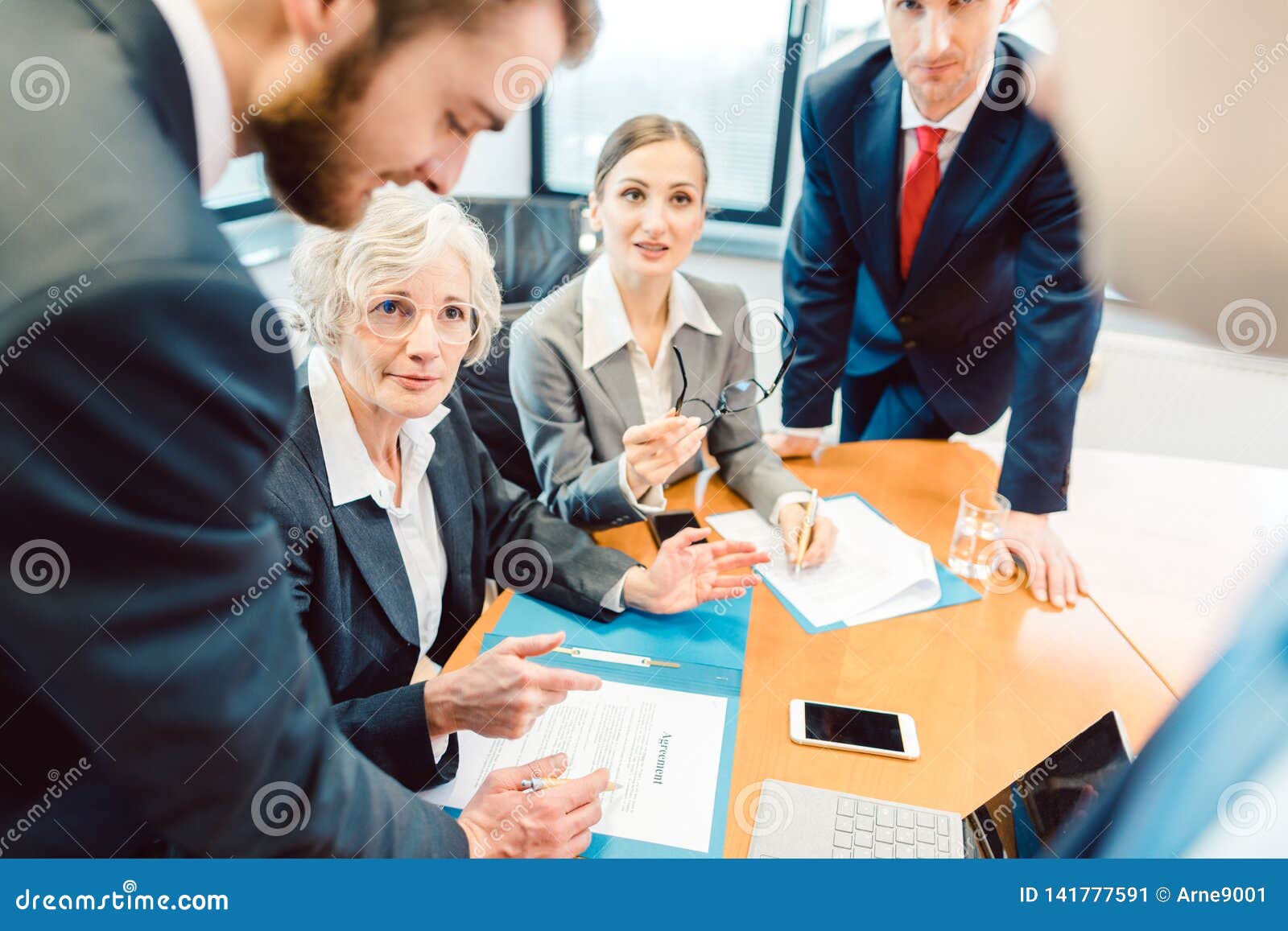 Business People during Negotiation of an Agreement Discussing Stock ...