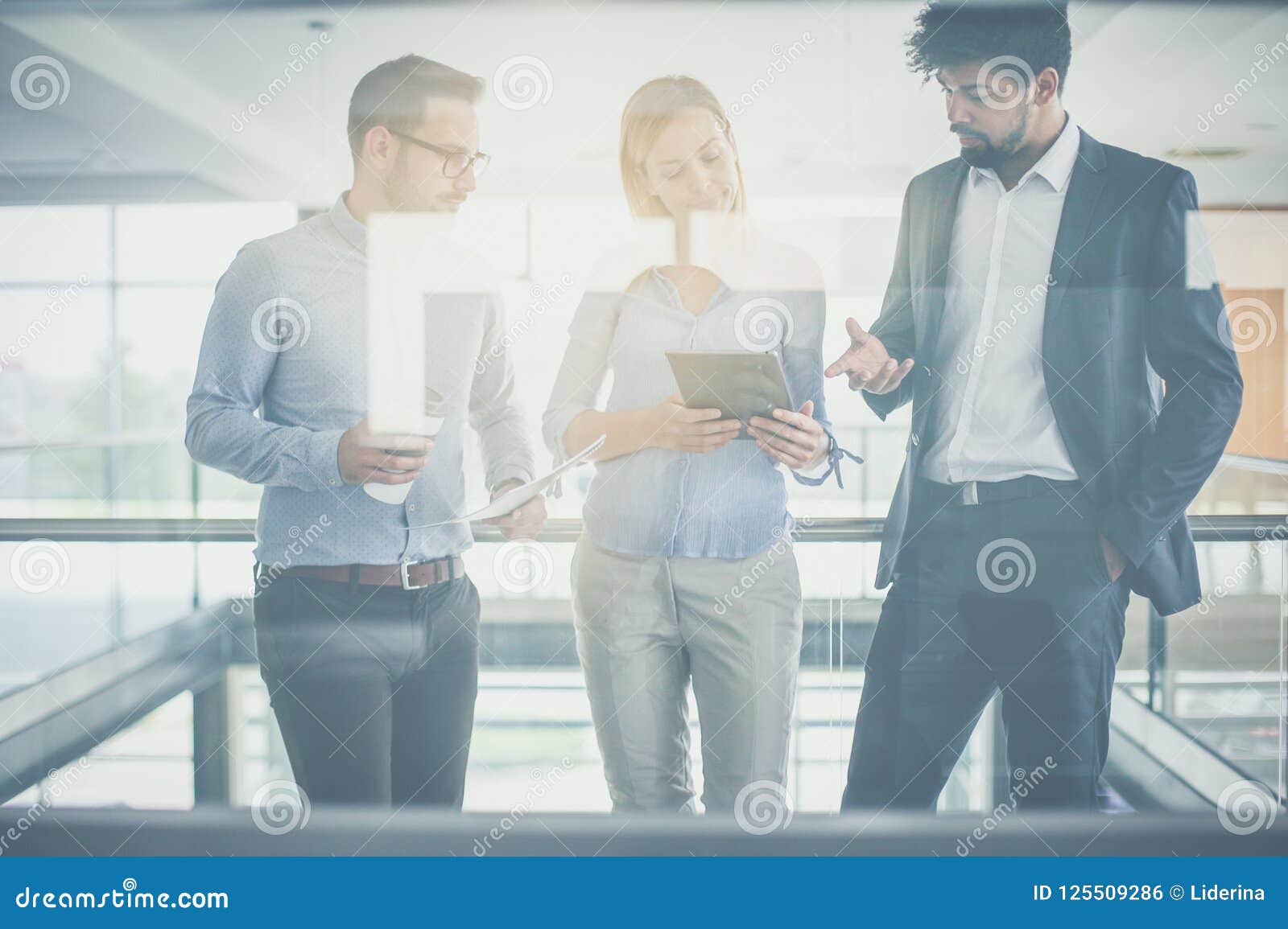 Business People in Office Having Conversation and Using Technology ...