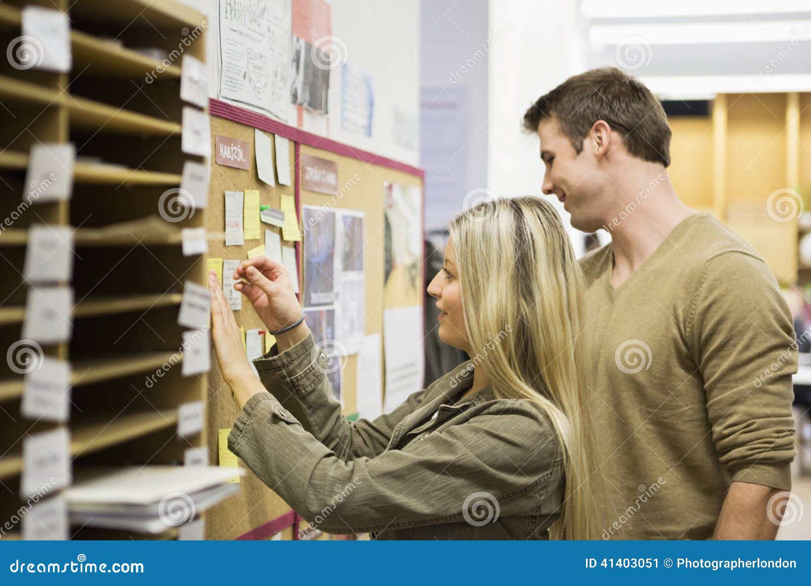 Business People Reading Reminders on Bulletin Board in Office Stock ...