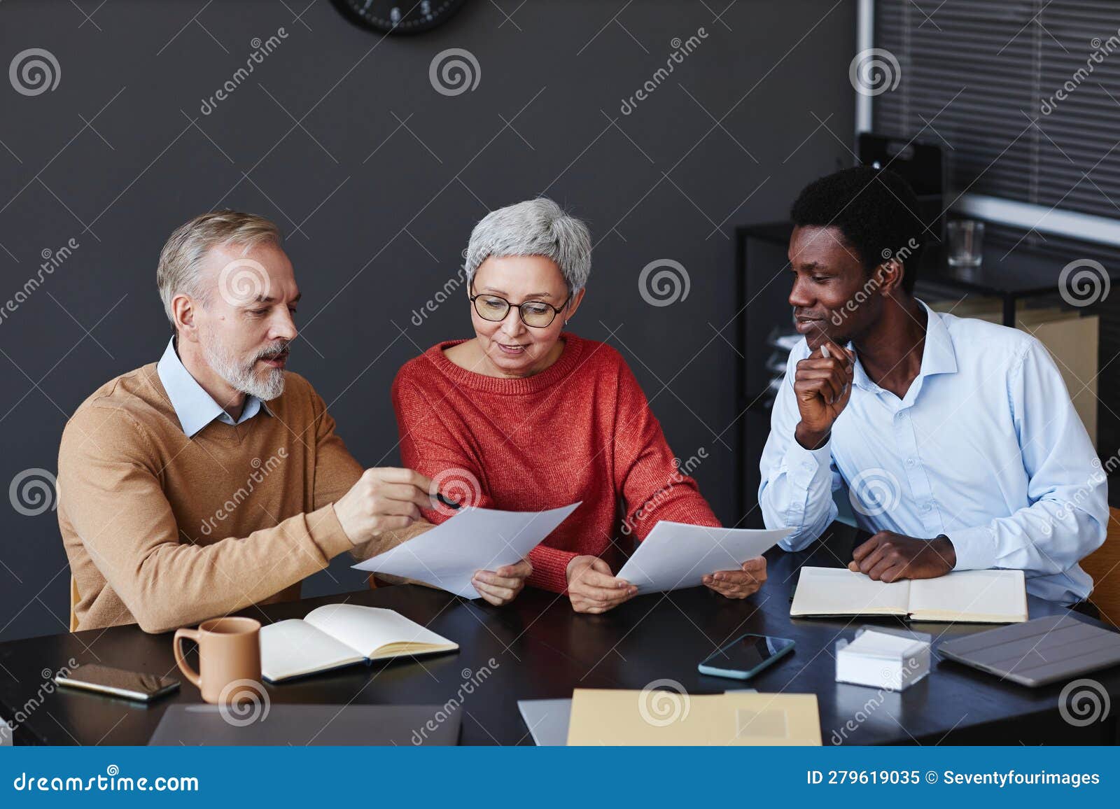 Business People with Senior Workers Collaborating on Project Stock ...