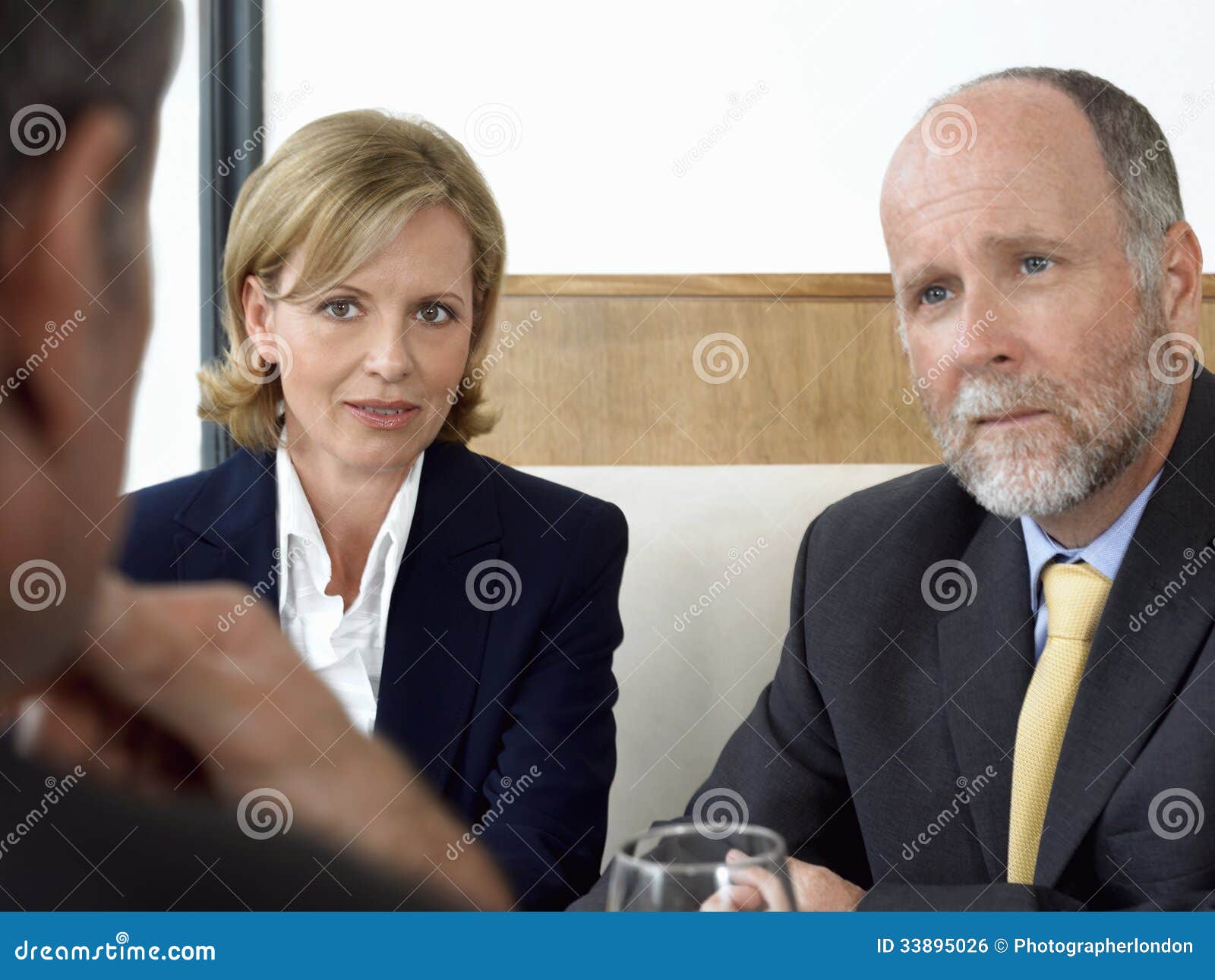 Business People in Serious Discussion at Restaurant Stock Photo - Image ...