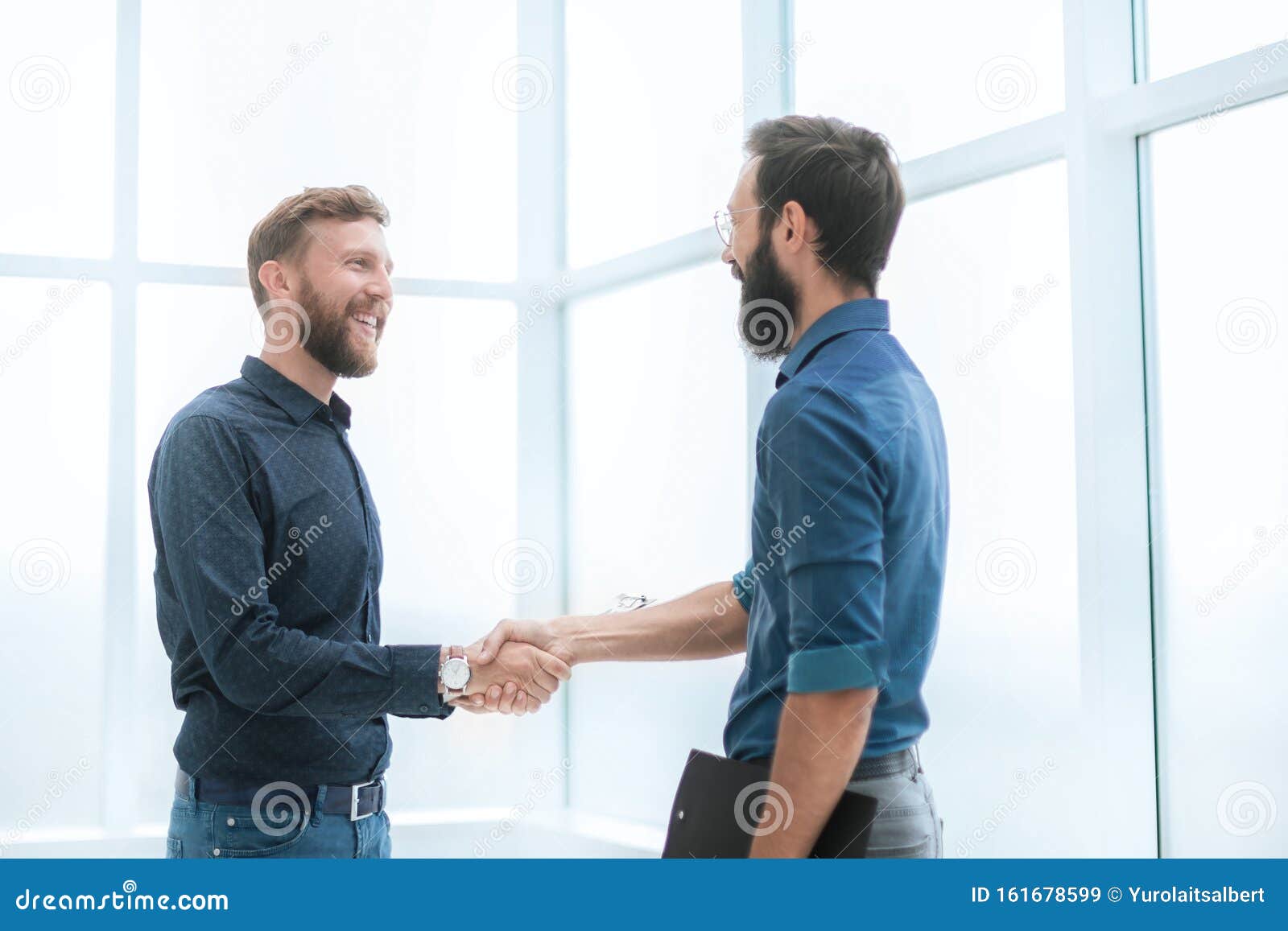 Business People Shaking Hands in a Bright Office Stock Image - Image of ...