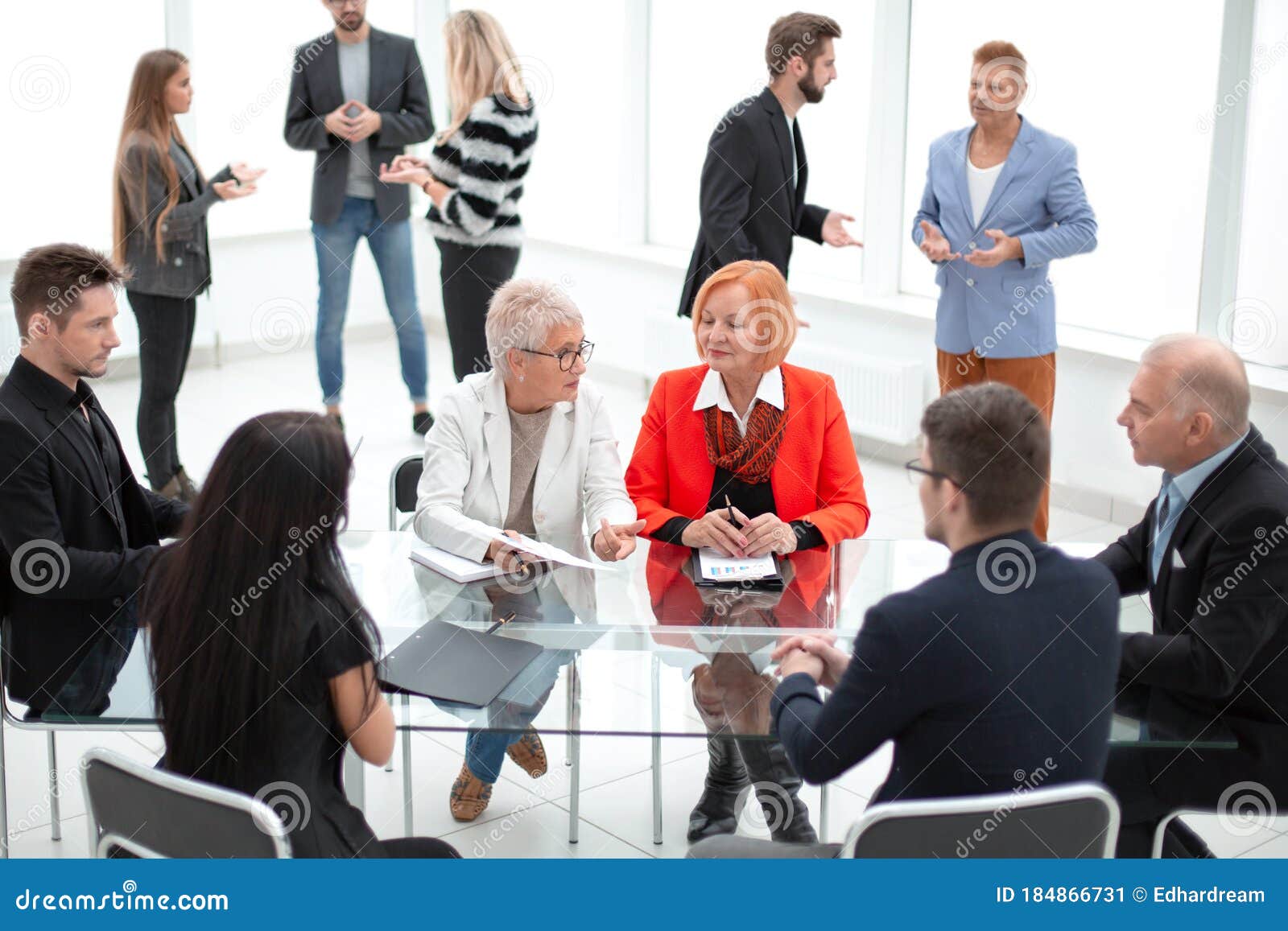 Business People Sitting Around the Desk in a Meeting and Making Stock ...