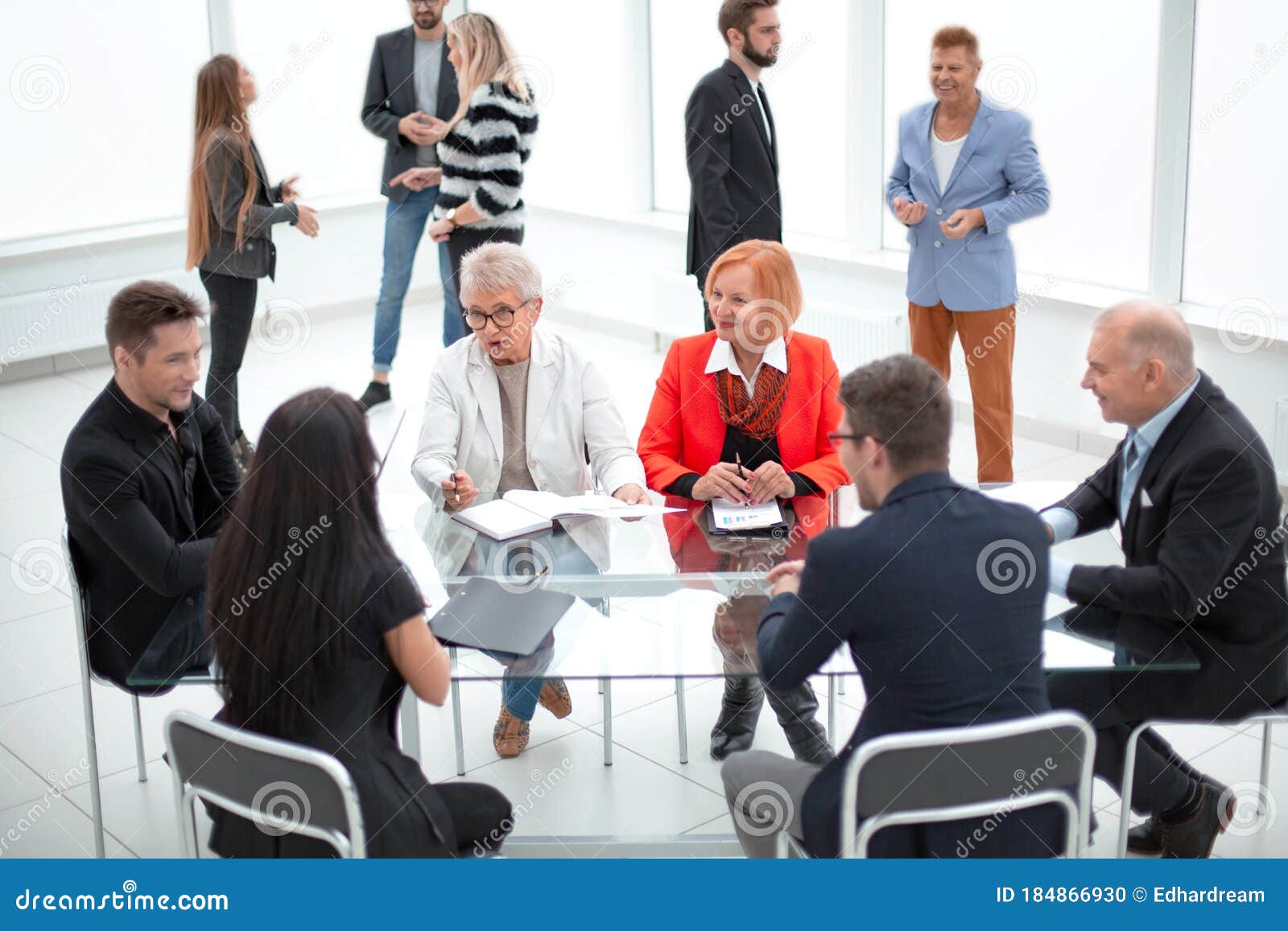 Business People Sitting Around the Desk in a Meeting and Making Stock ...