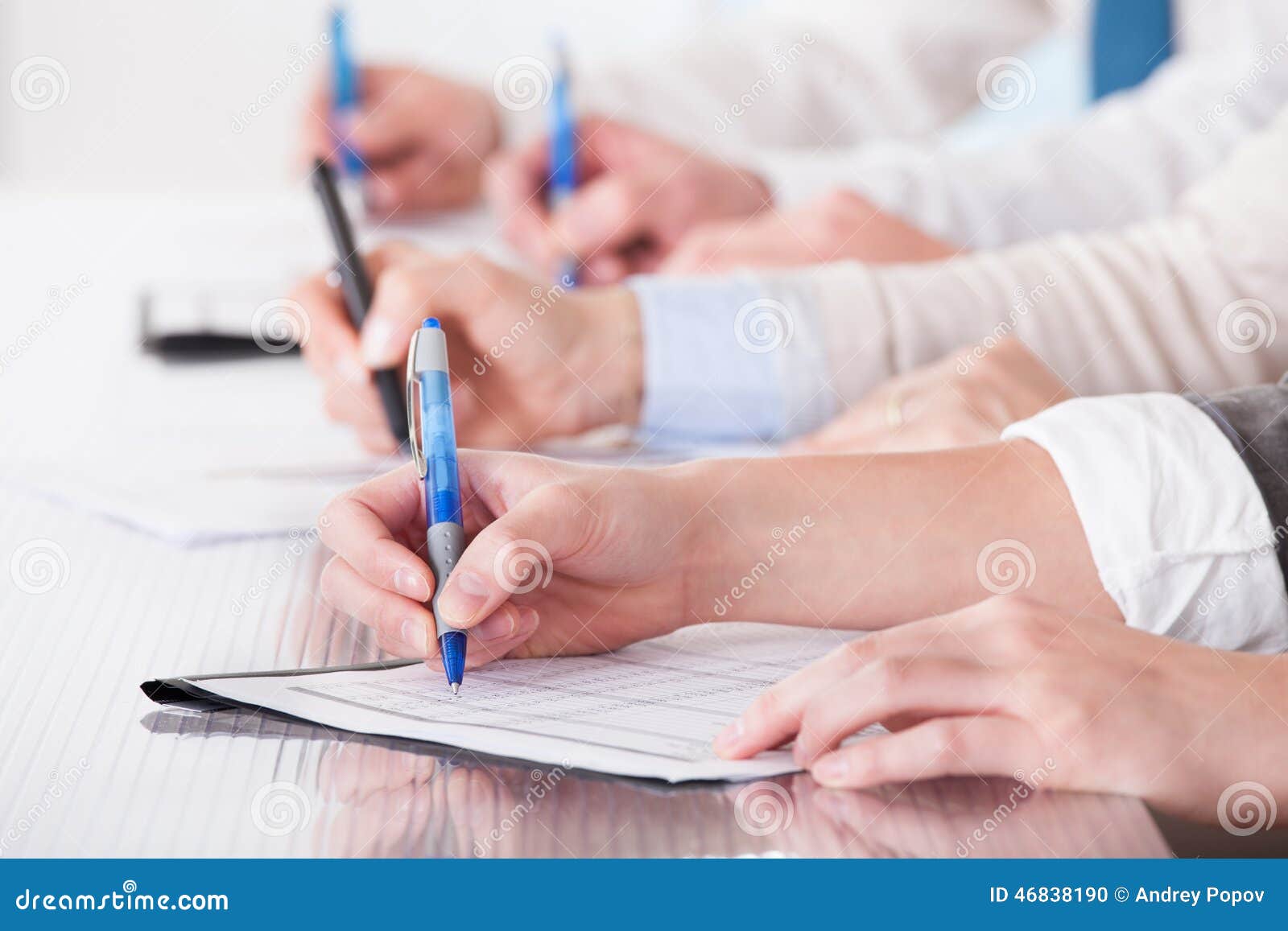 Business People Sitting in a Row and Writing Notes Stock Photo - Image ...