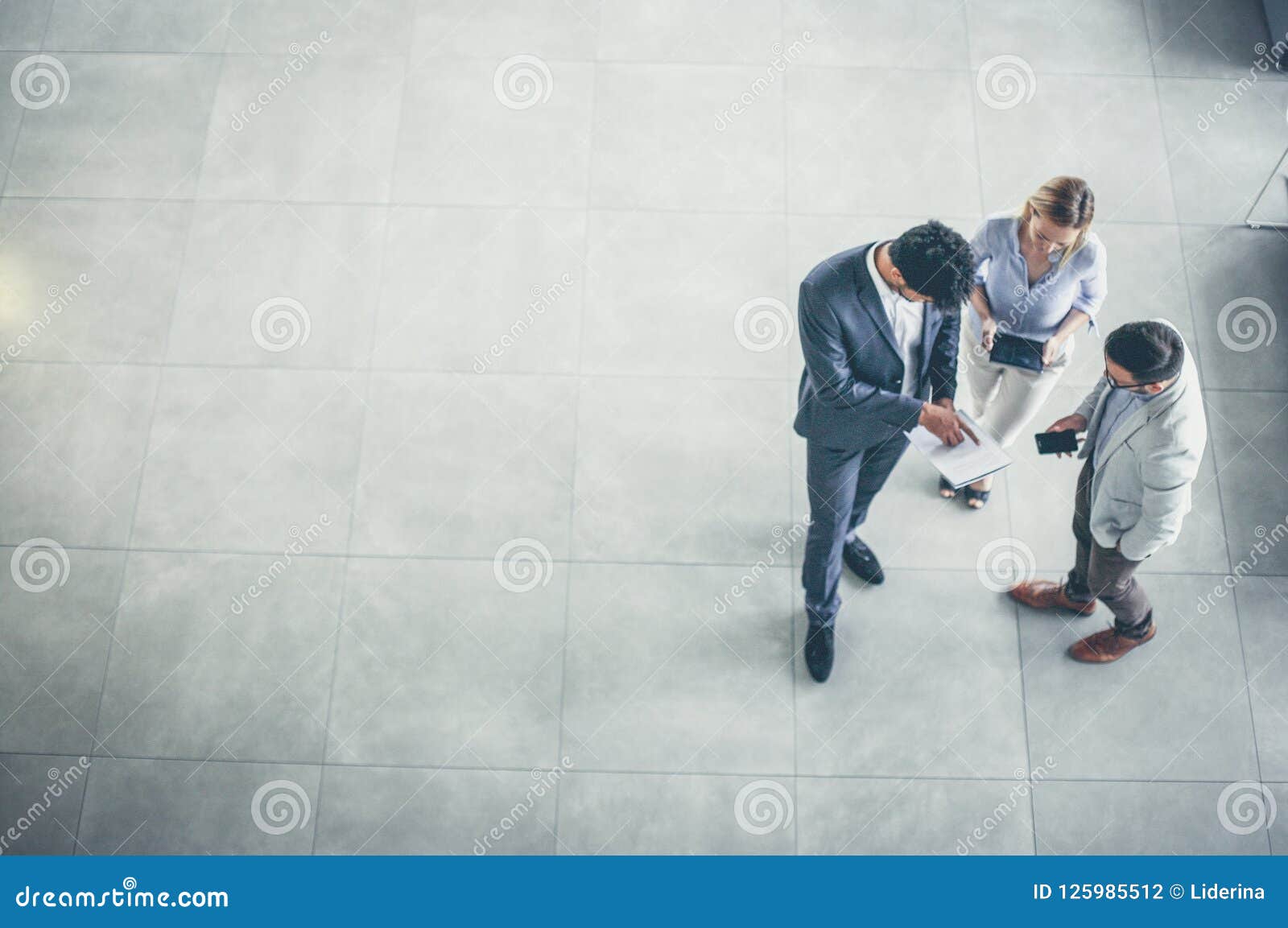 Business People Standing in Business Building and Having Conversation ...