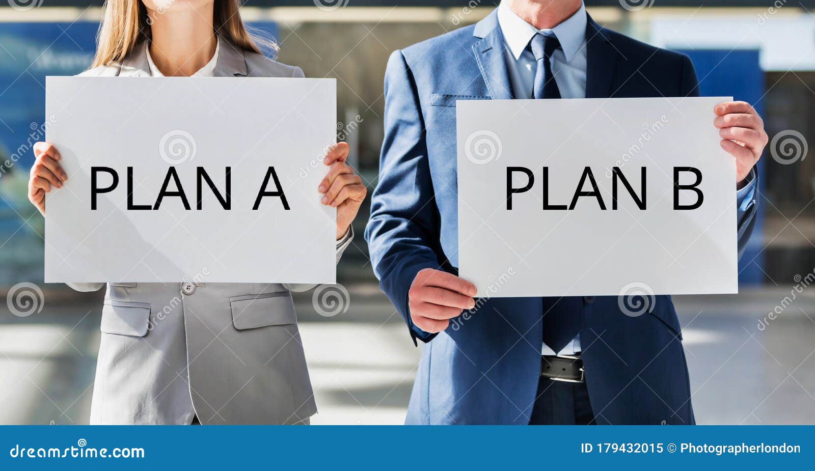 Business People Standing while Holding PLAN a and PLAN B White Placard ...