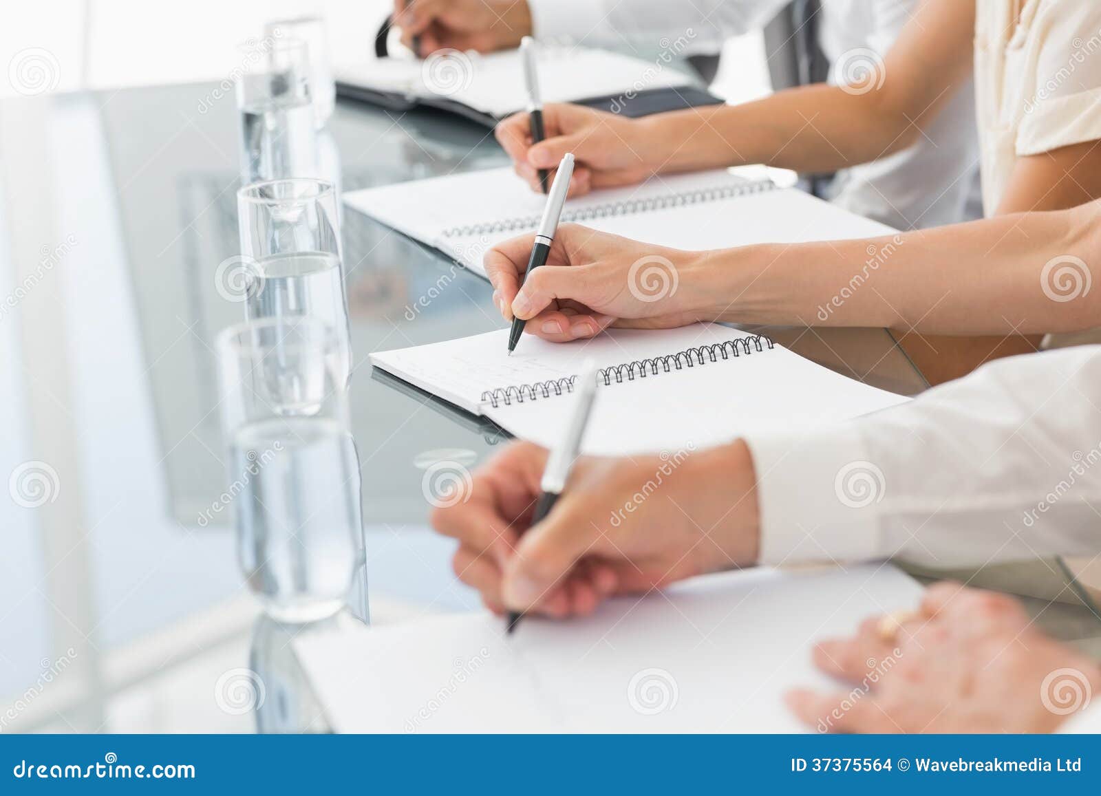 Business People Taking Down Notes at a Meeting Stock Photo - Image of ...