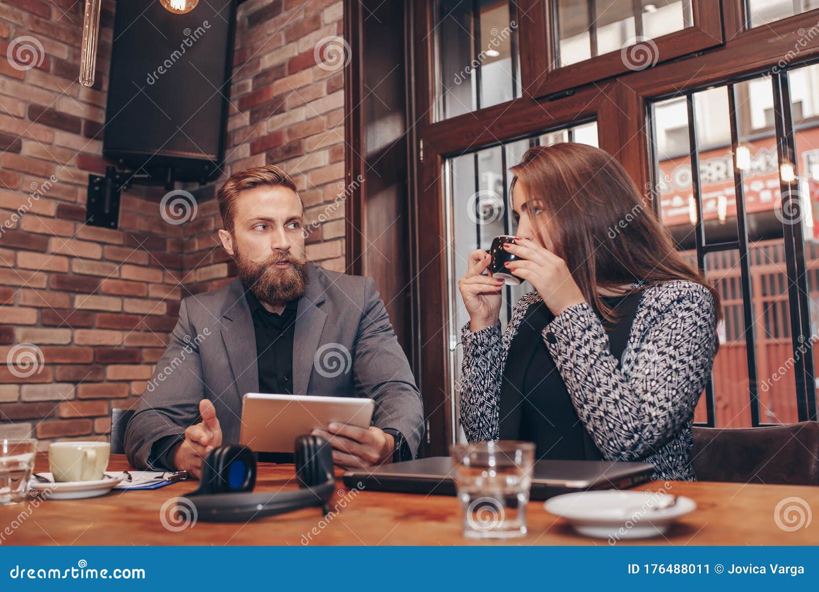 Business People are Using Digital Tablet, Talking, Drinking Coffee in ...